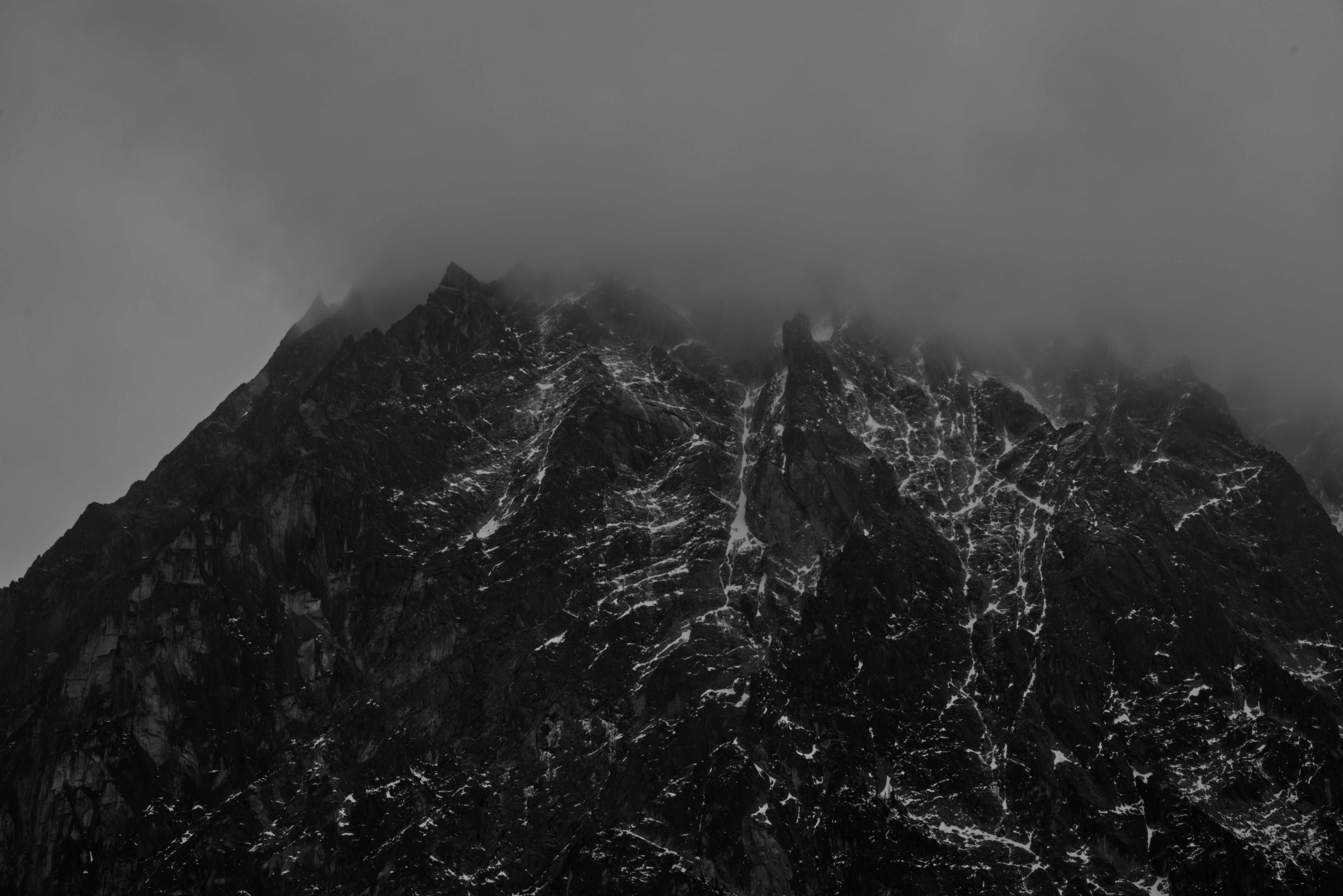 Snow-capped mountain peak shrouded in mist