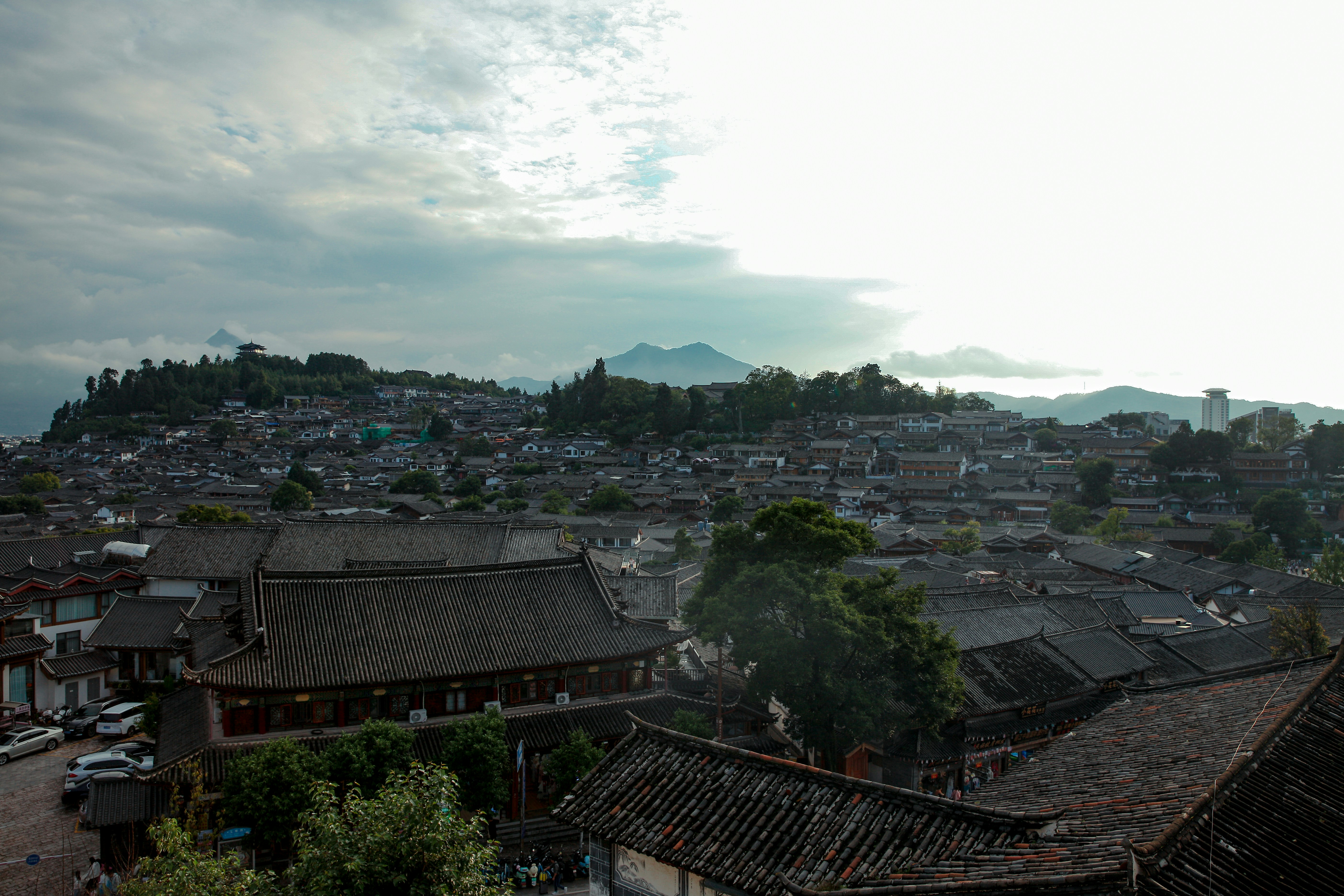 A thousand-year-old ancient city | A traditional village nestled on a hillside under clouds