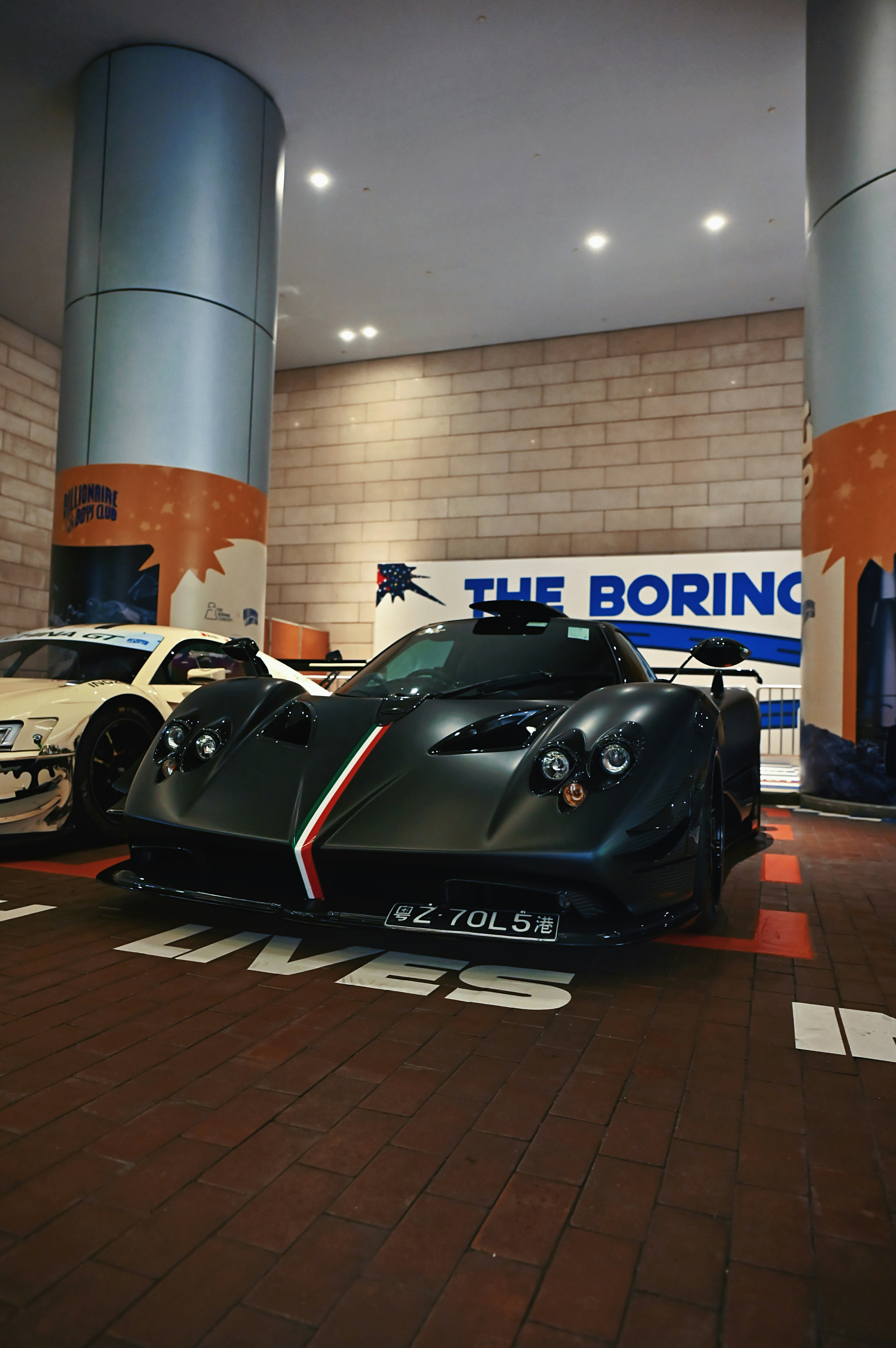 McLaren P1,720s,Audi R8,Porsche 911GT3,Pagani Zonda,Ferrari LaFerrari,supercars,hypercars | A dark sports car parked indoors with brick wall