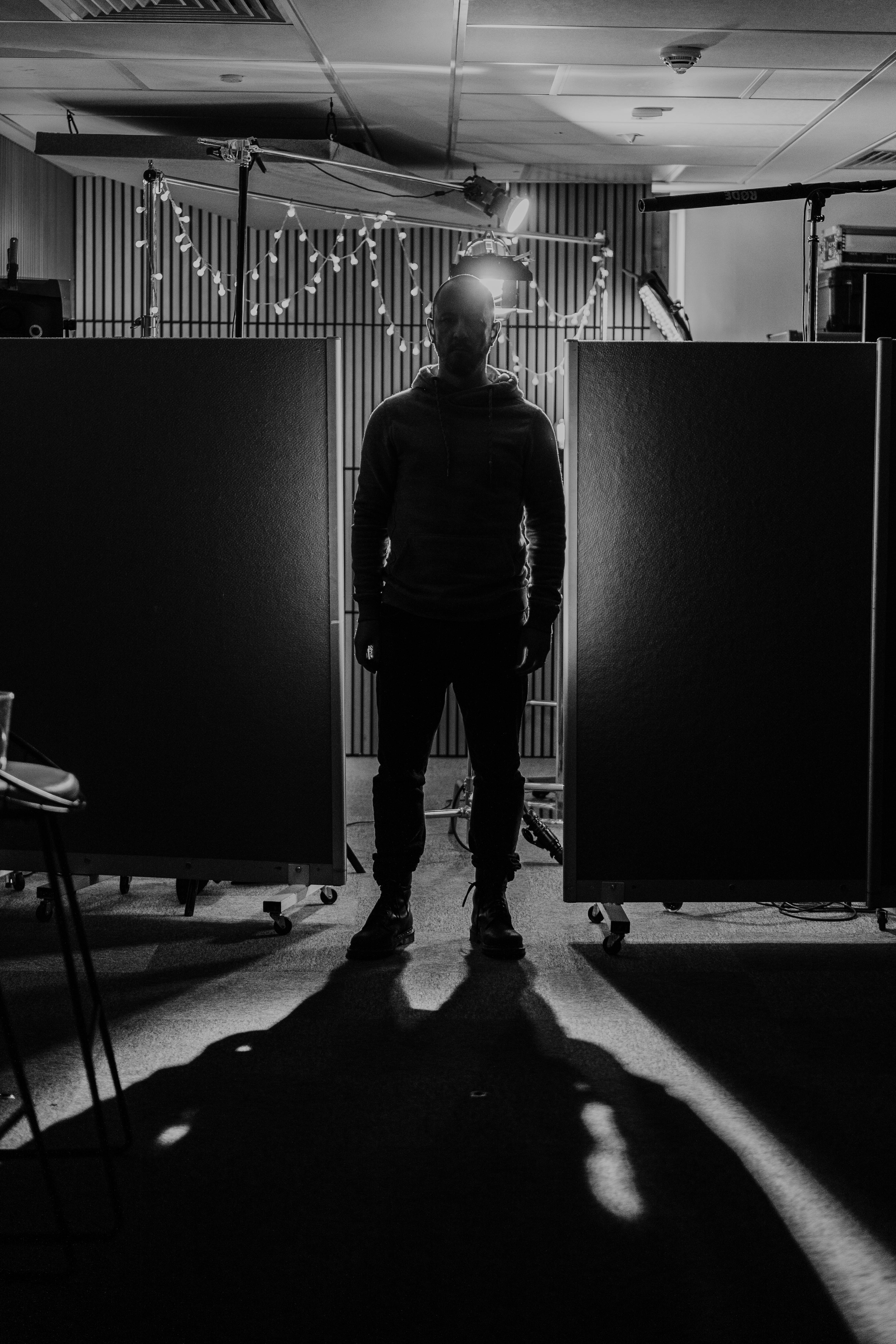 Silhouetted Presence Amidst Studio Shadows