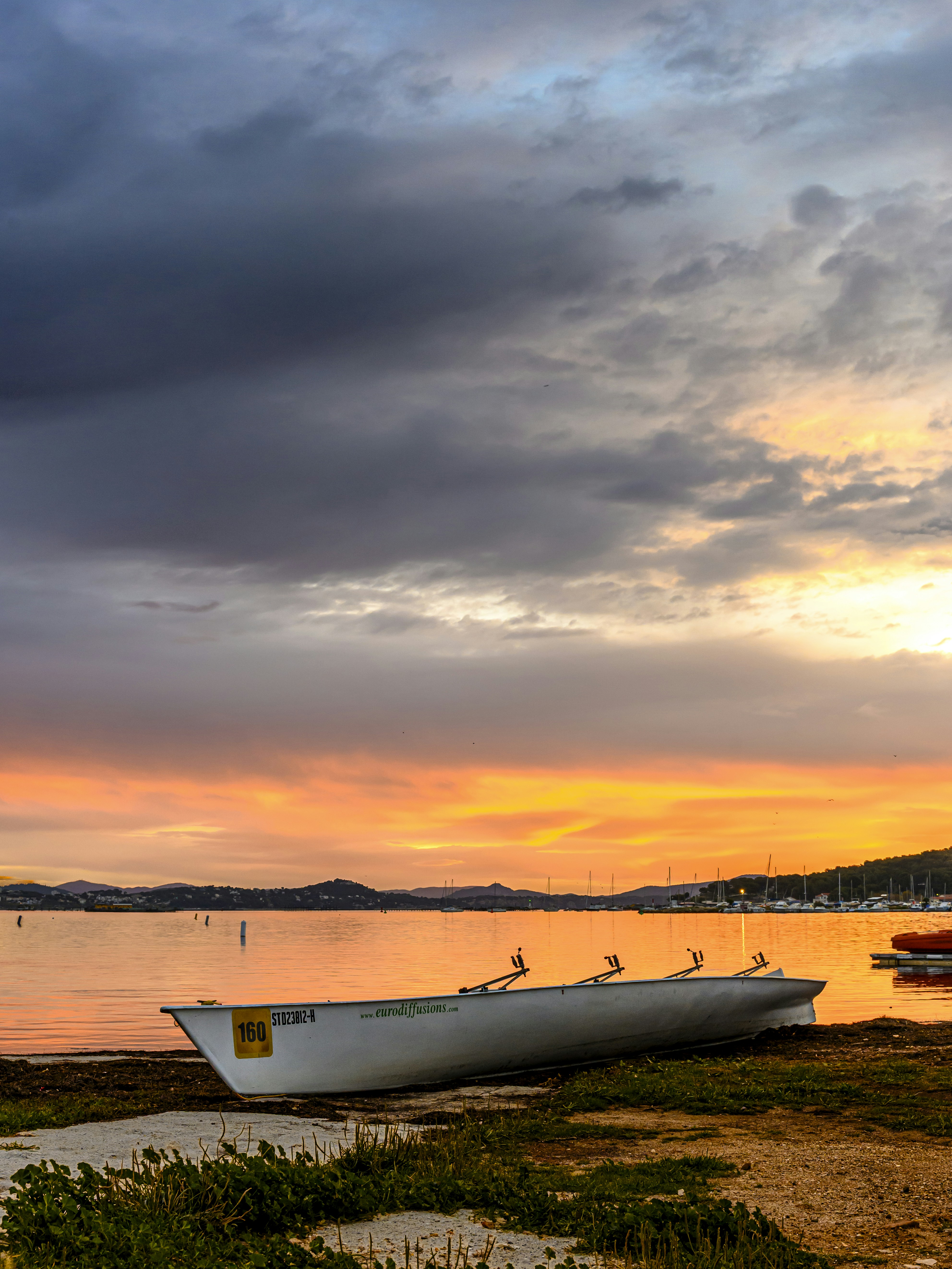 Tranquil Waters at Dusk: A Rowboat's Reflection