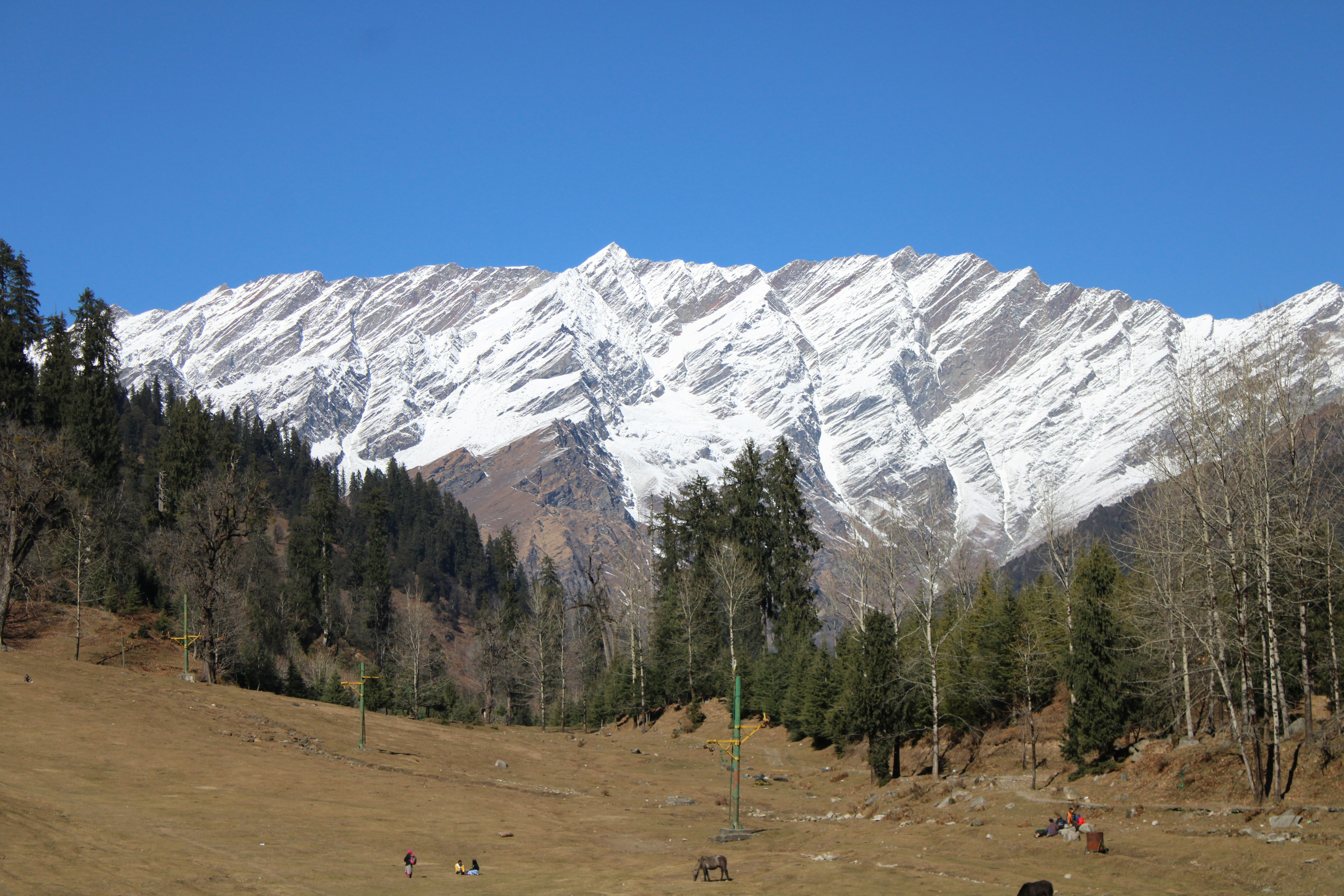 Snow-covered mountains under a clear blue sky.