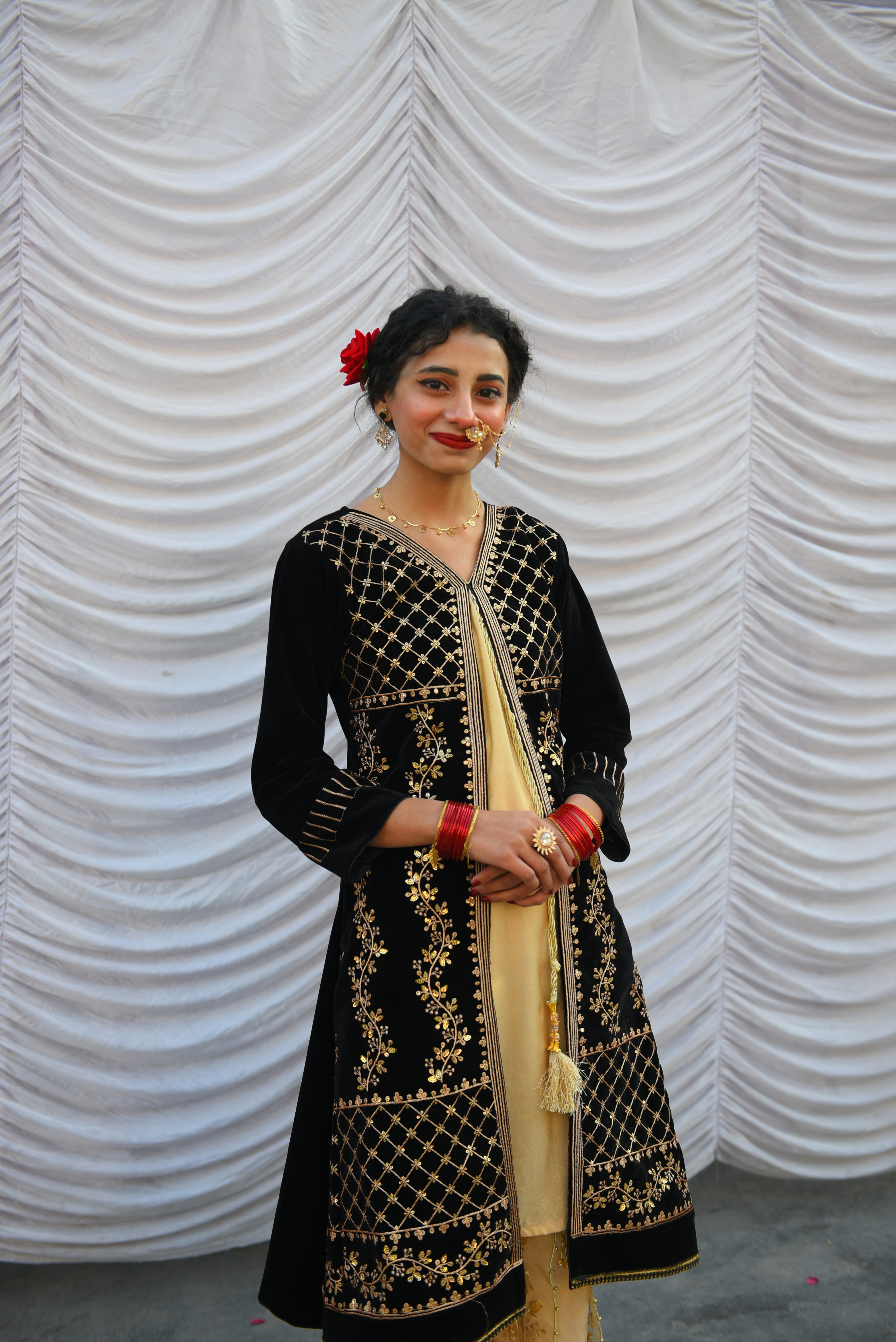 Pakistani girl | Woman in traditional black and gold embroidered outfit.