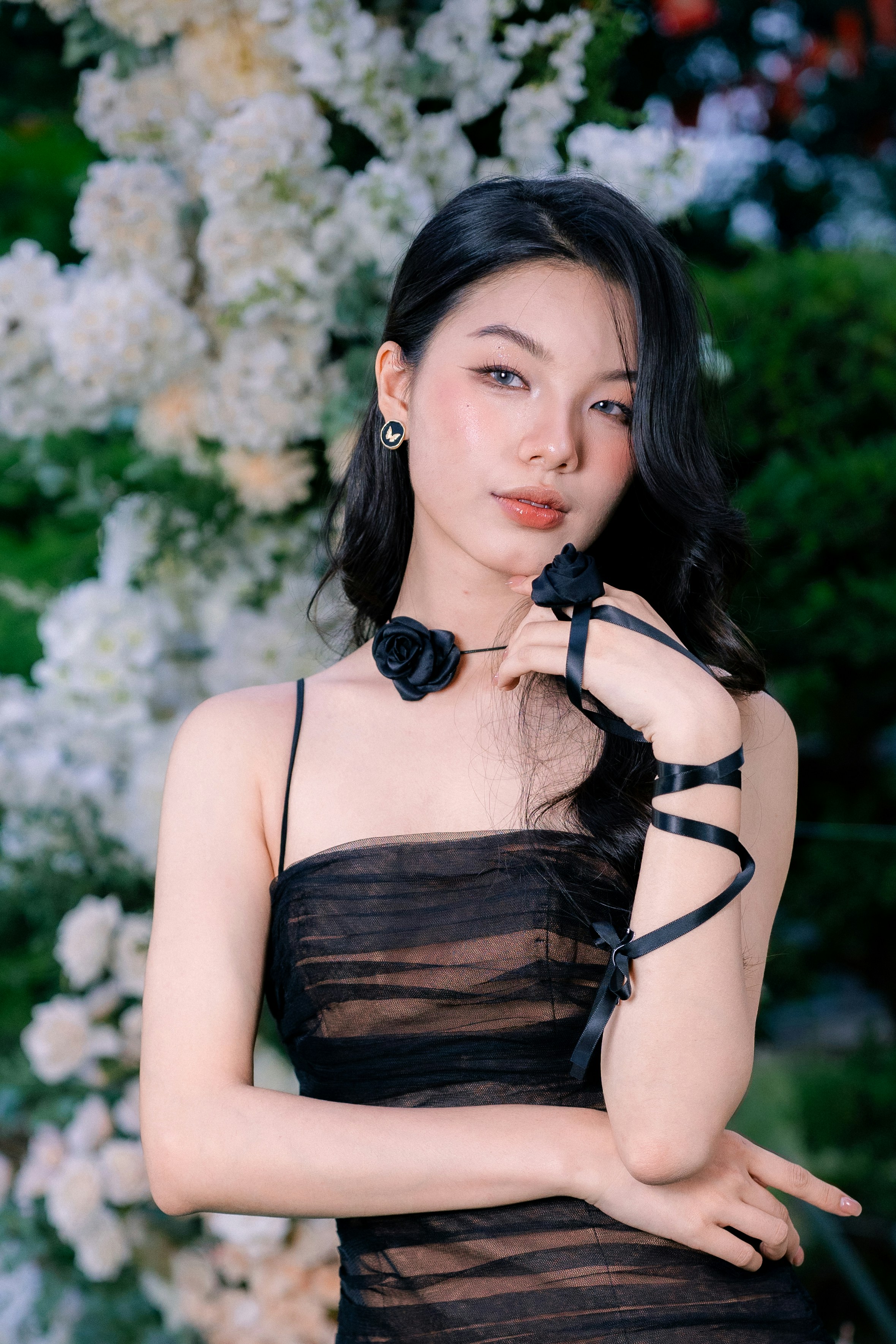 woman in a black fashion dress | Young woman in black dress with floral accents