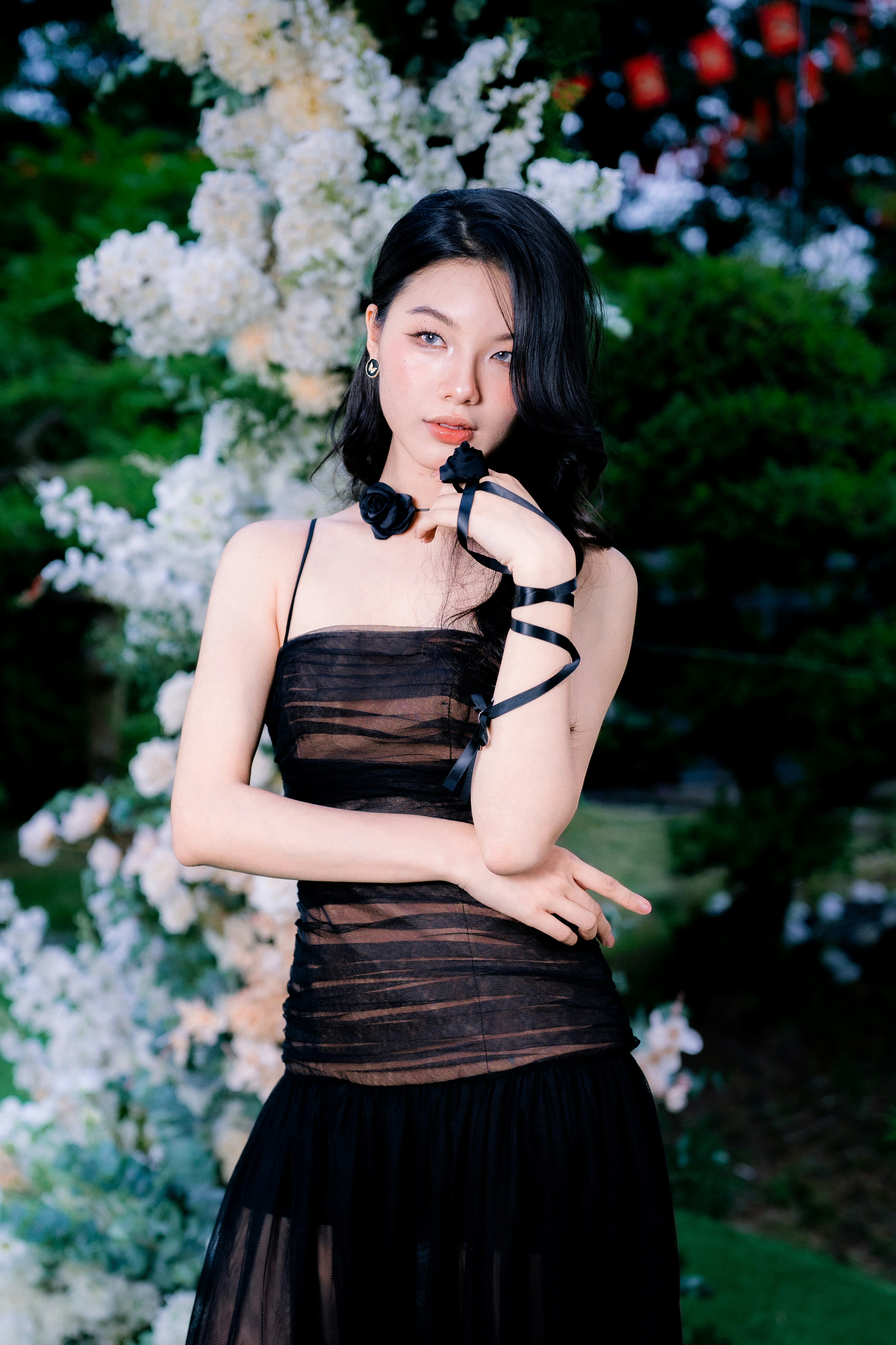 woman in a black fashion dress | A young woman in a black dress outdoors