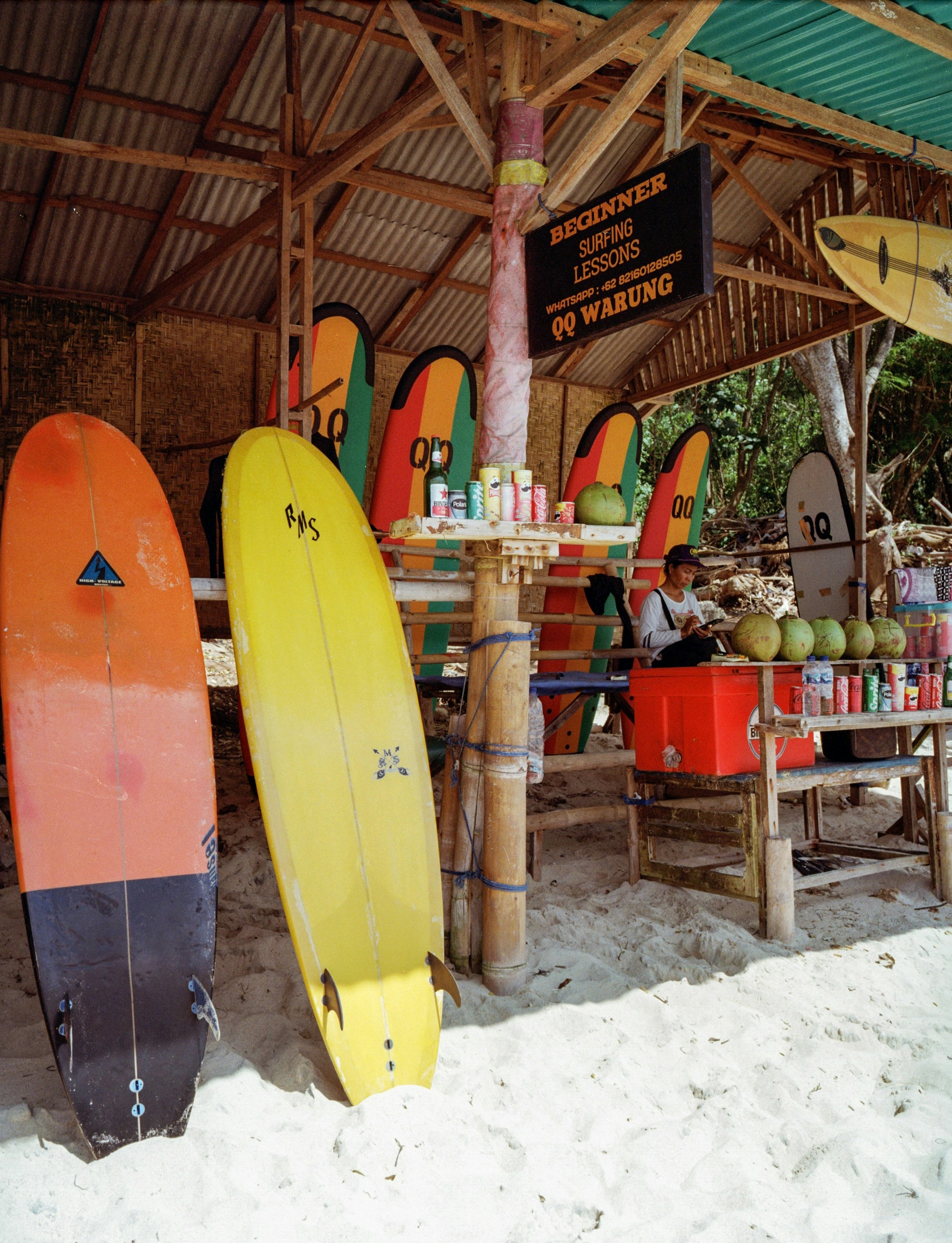 Kodak Gold 200 🎞️ | Surfboards lined up outside a beachside shack with drinks.