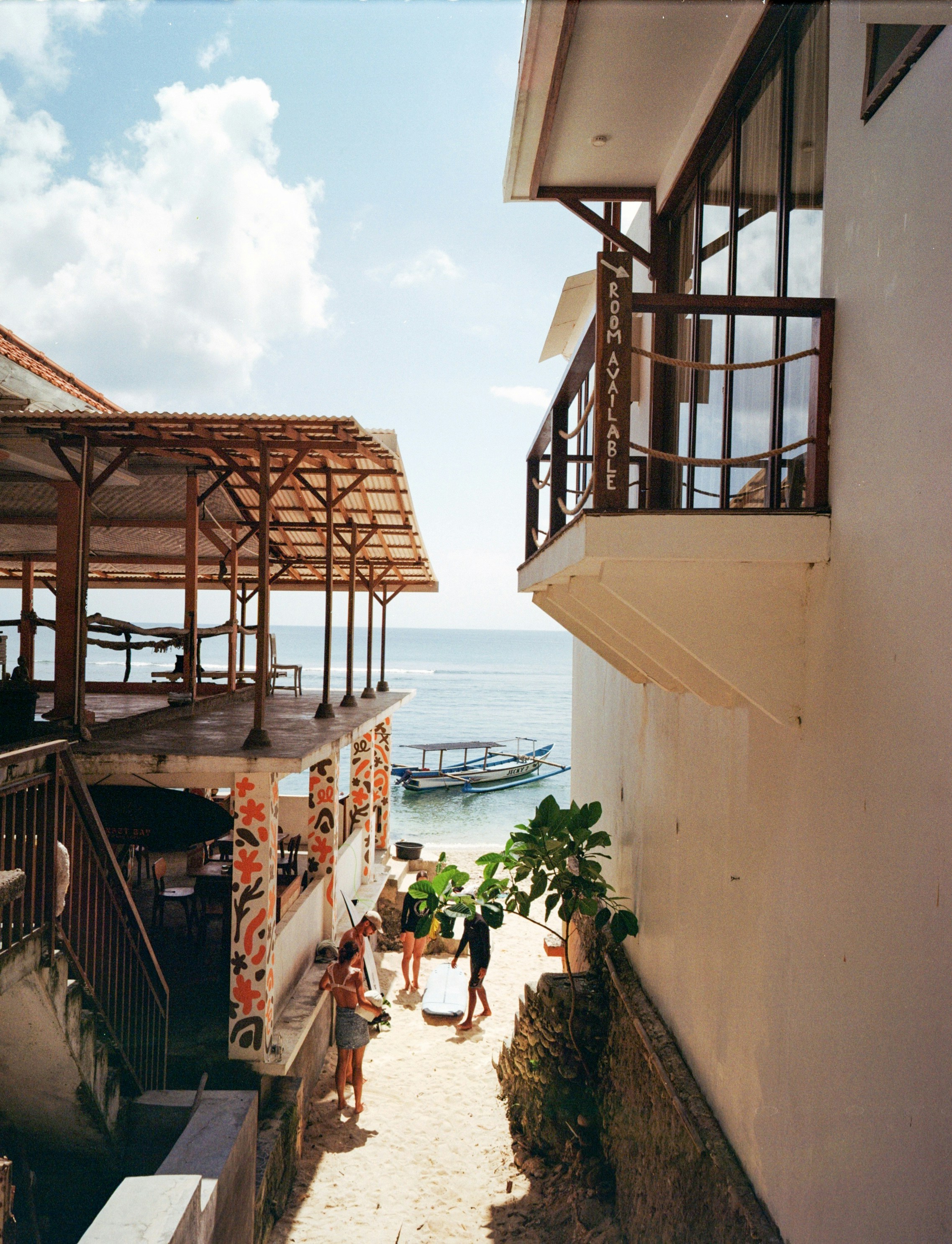 Kodak Gold 200 🎞️ | Tropical beach path leading to ocean with buildings.