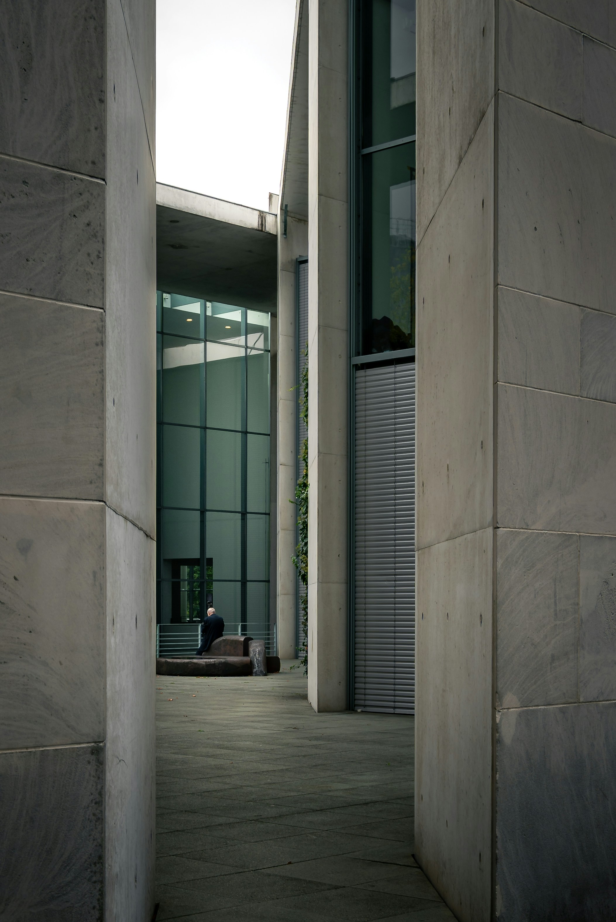 Modern architecture with a lone figure sitting