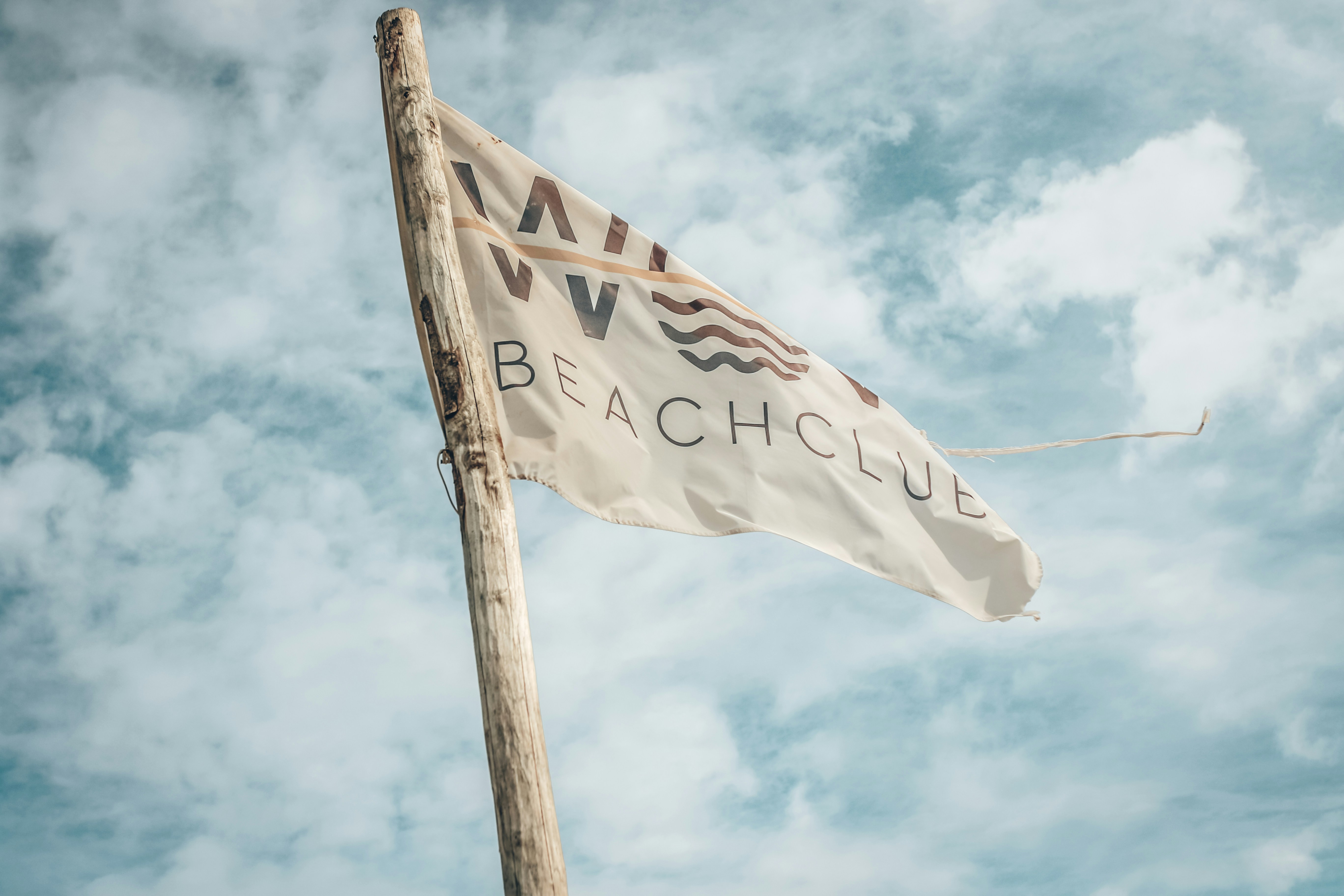 Waves of Relaxation: A Beach Club's Emblem in Motion