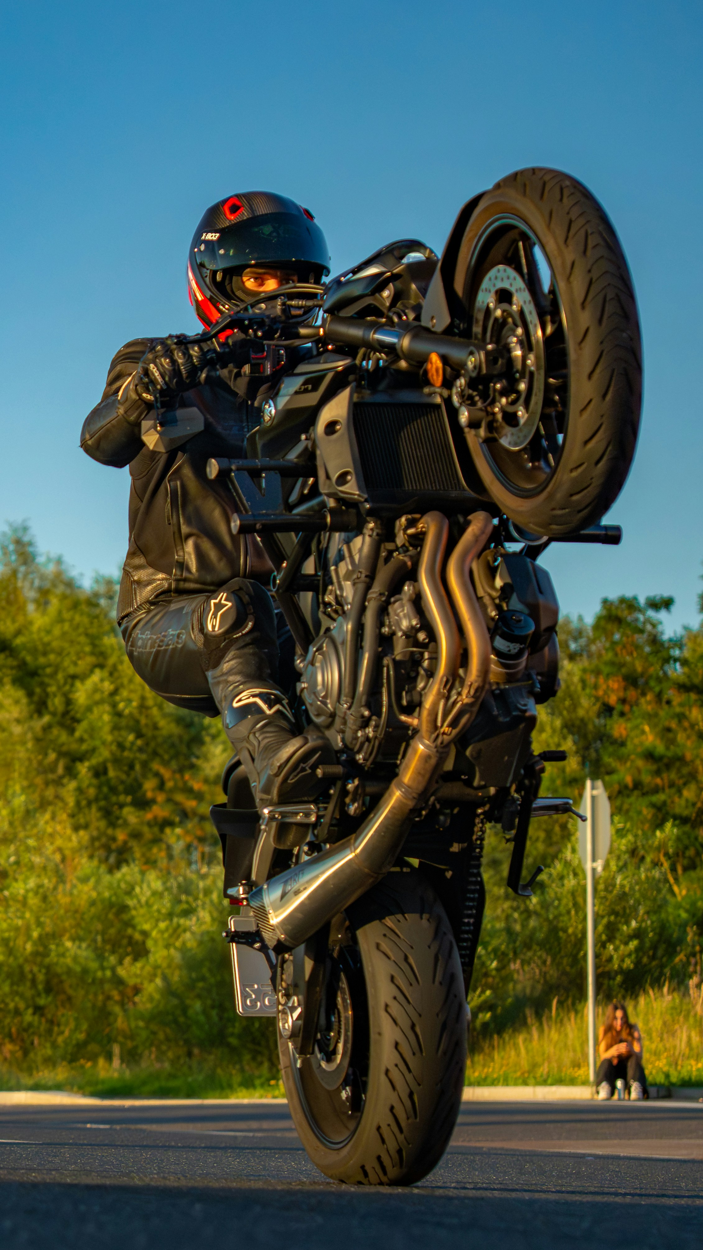 Golden Hour Wheelie: Precision Balance Beneath a Blue Sky