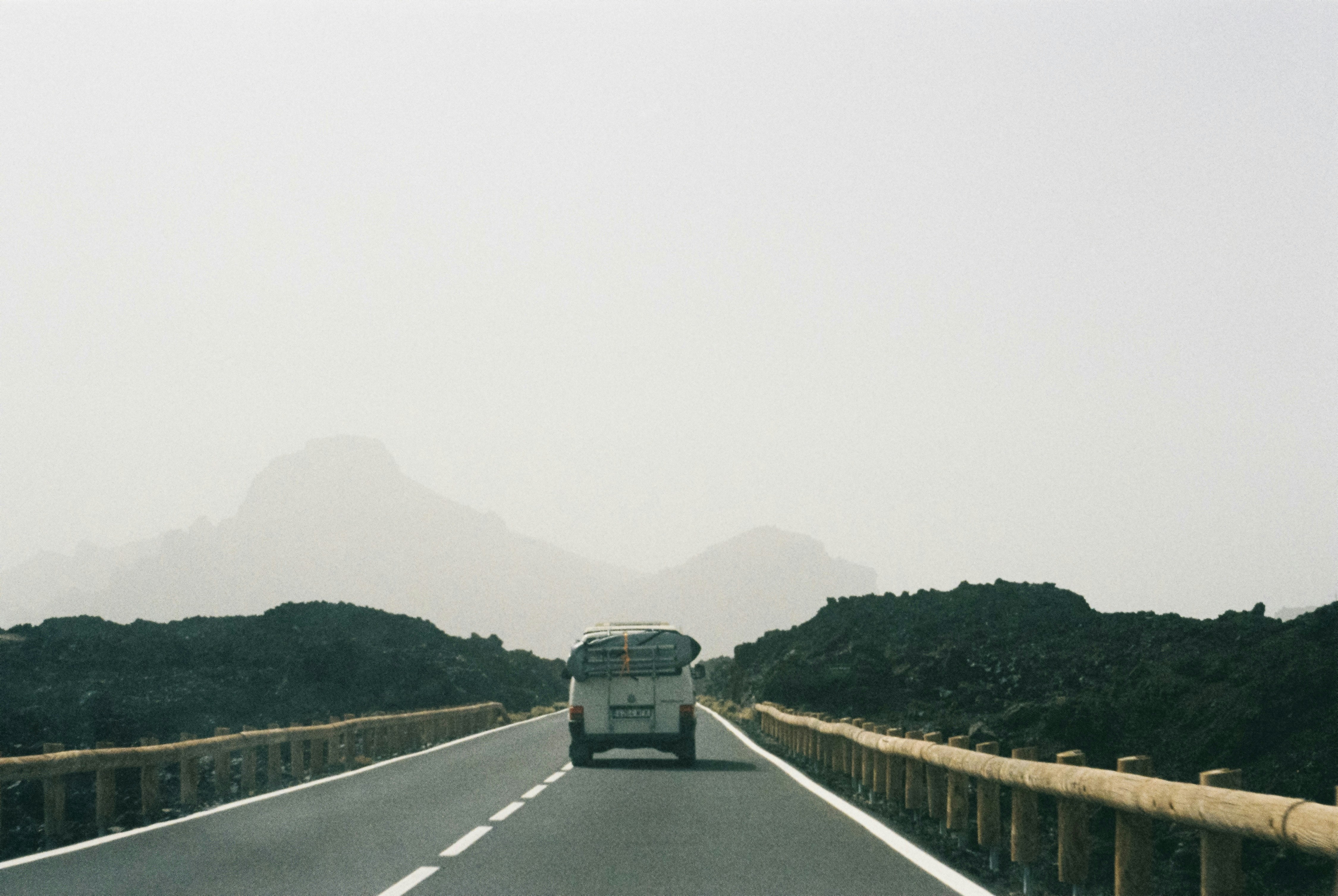 Roadtrip around Tenerife | Van driving on a road with mountains in background