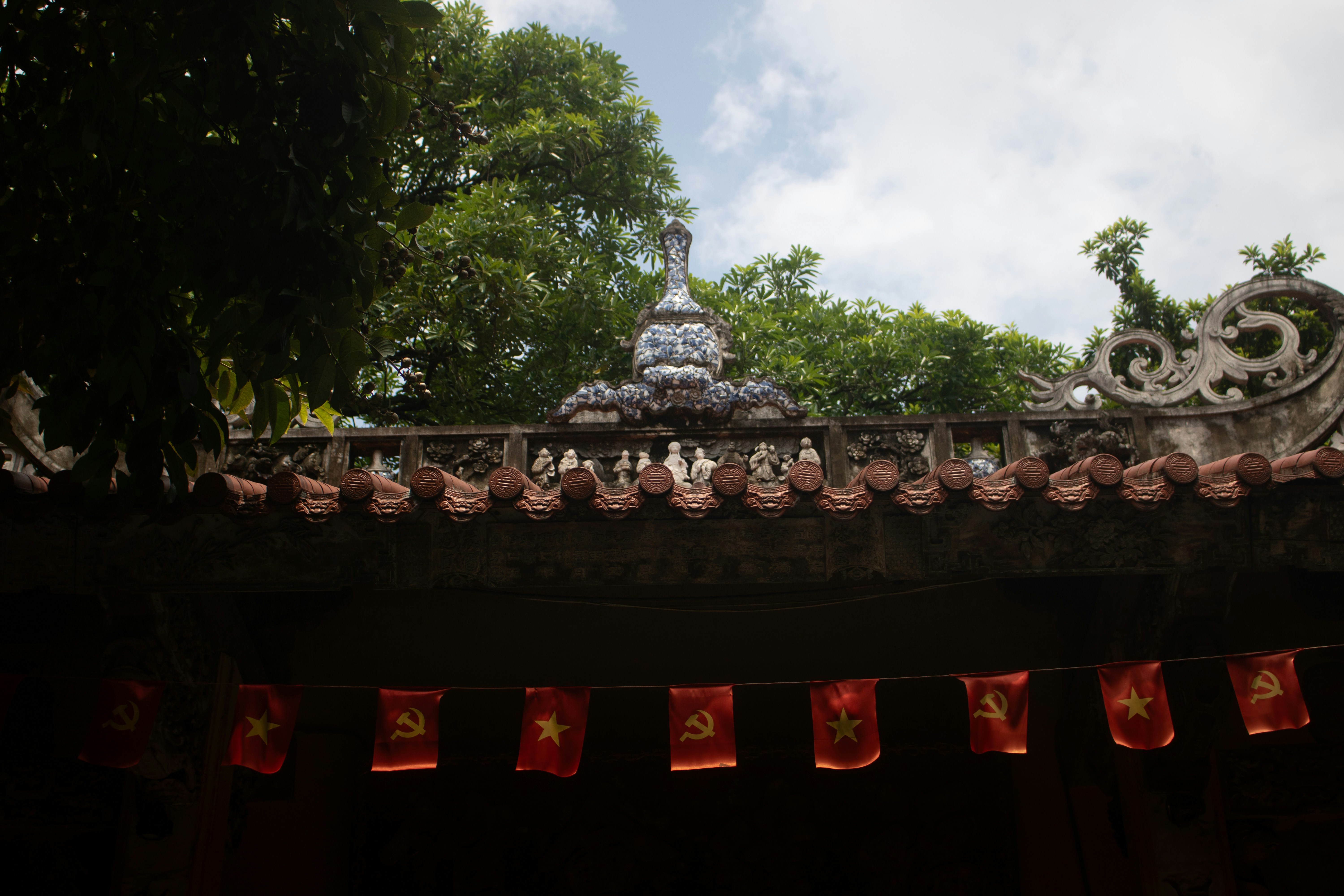 Ornate temple roof with red prayer flags