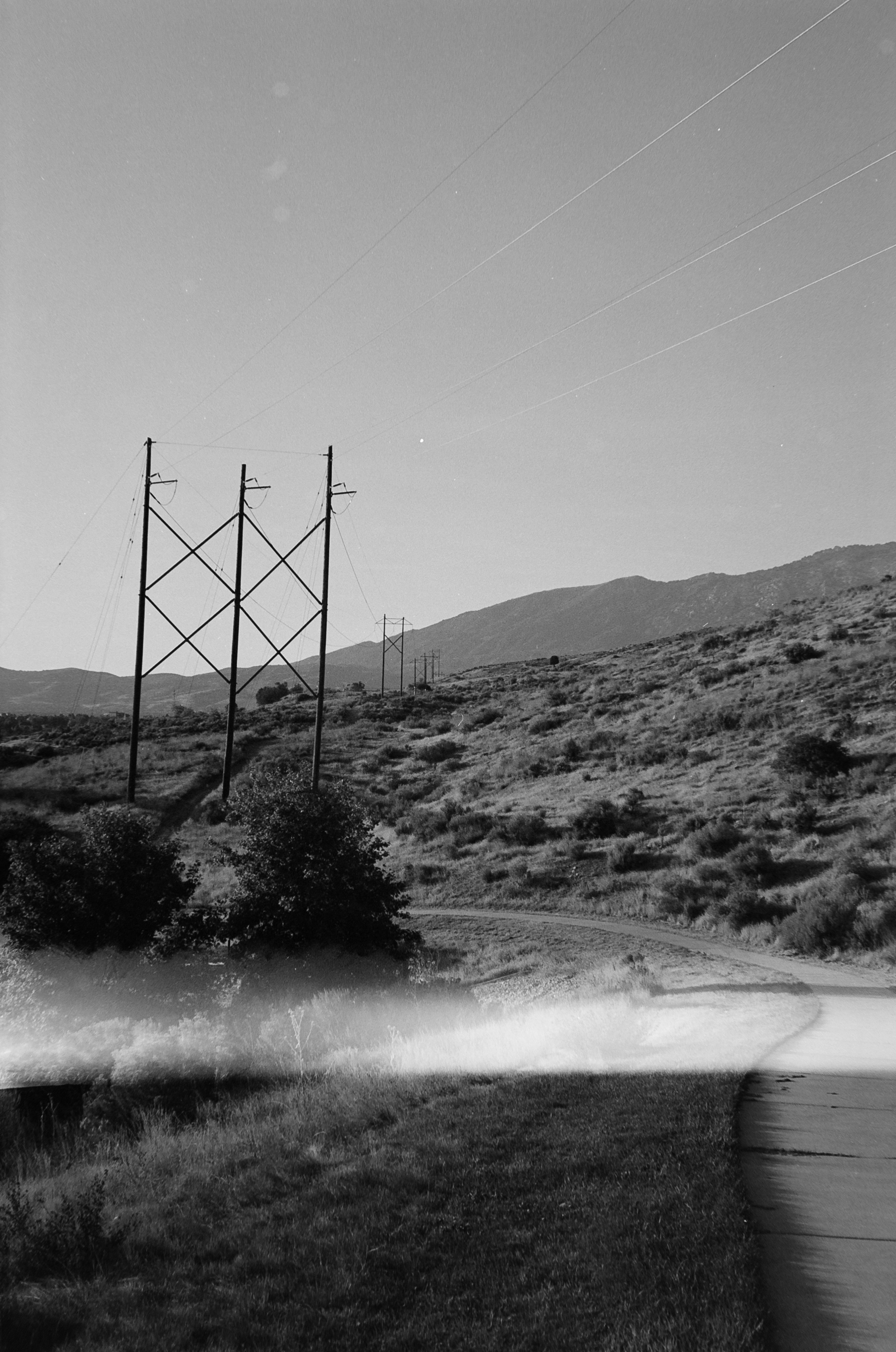 Power lines cross a dry, hilly landscape. photo – Free Grassland Image ...
