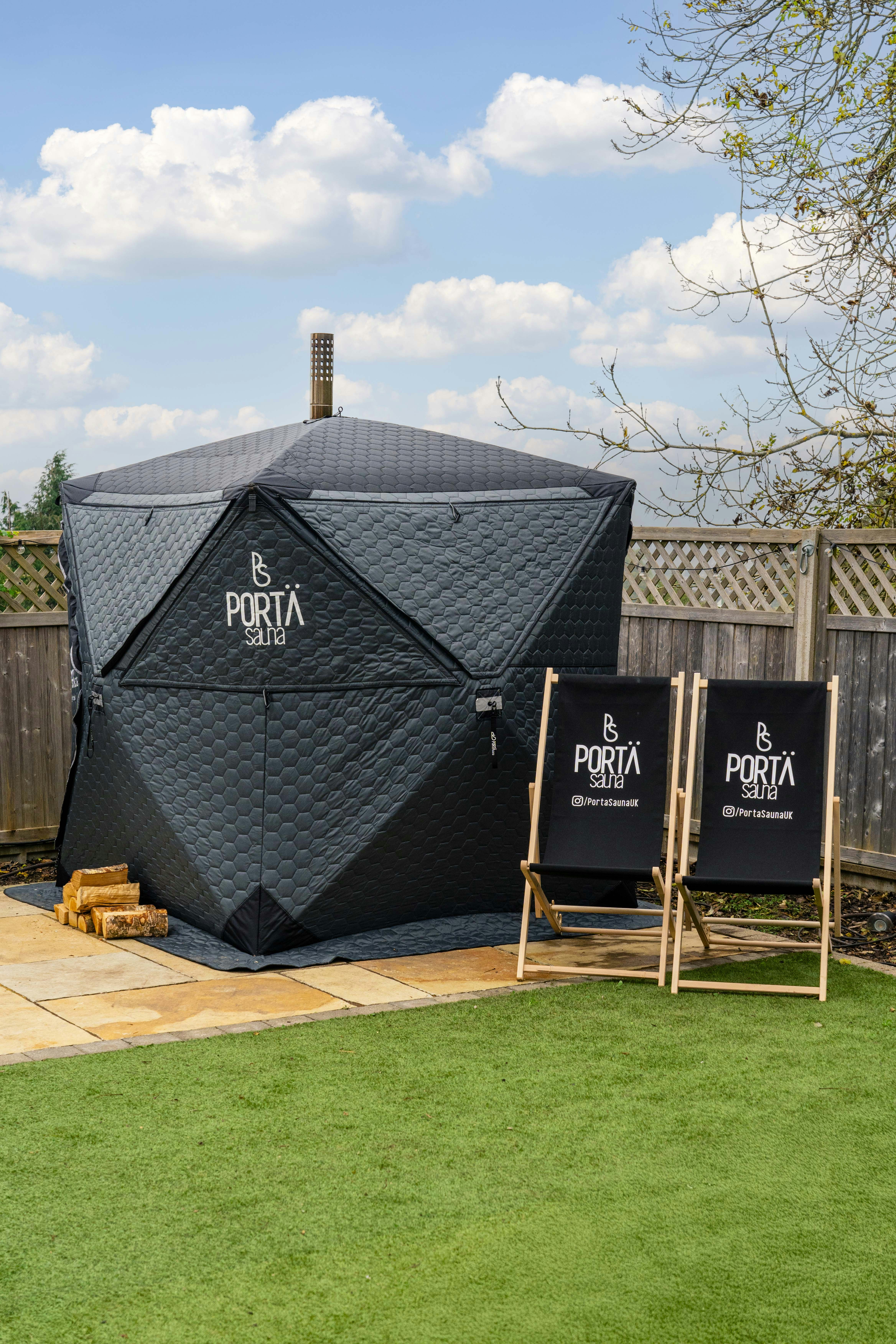 PortaSauna is a portable sauna perfect for both home use and outdoor adventures. Capable of reaching temperatures up to 100°C, it stands as the hottest and most durable portable sauna available on the market. https://portasauna.com/ | Portable sauna with chairs and firewood outside woodpile of wood