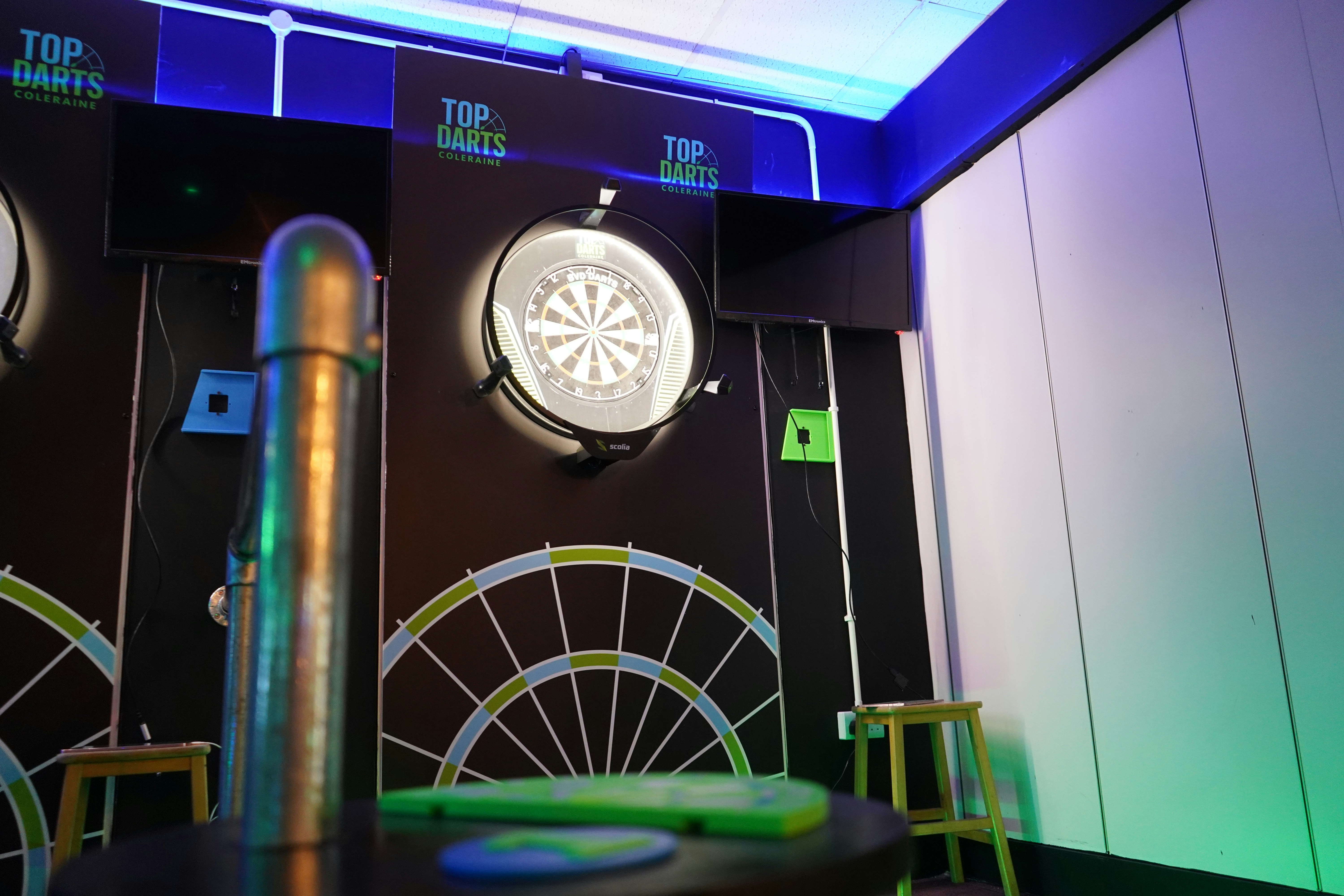 Neon Bullseye: Low-Angle View of a Darts Hall