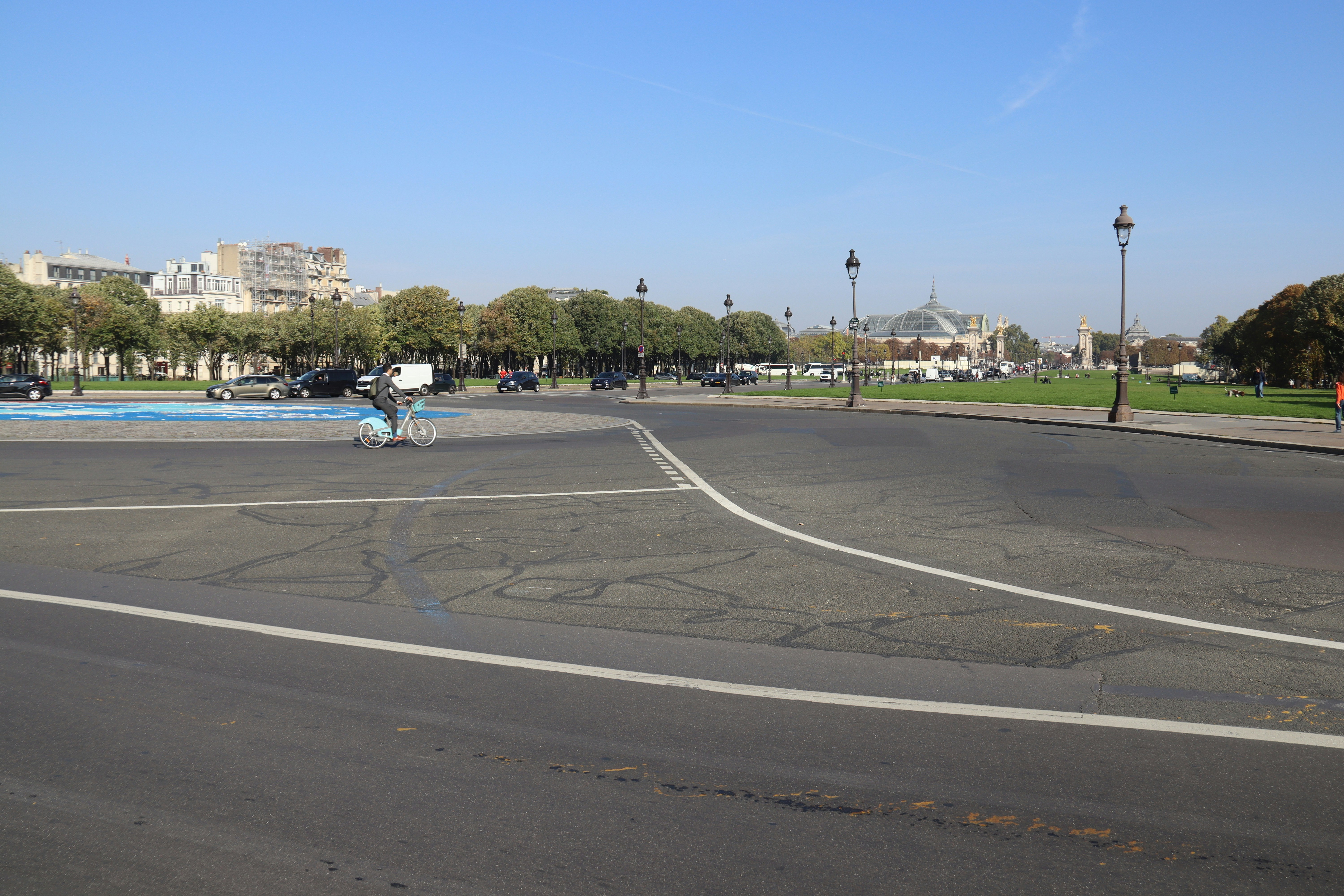 Wide open paved area with trees and buildings