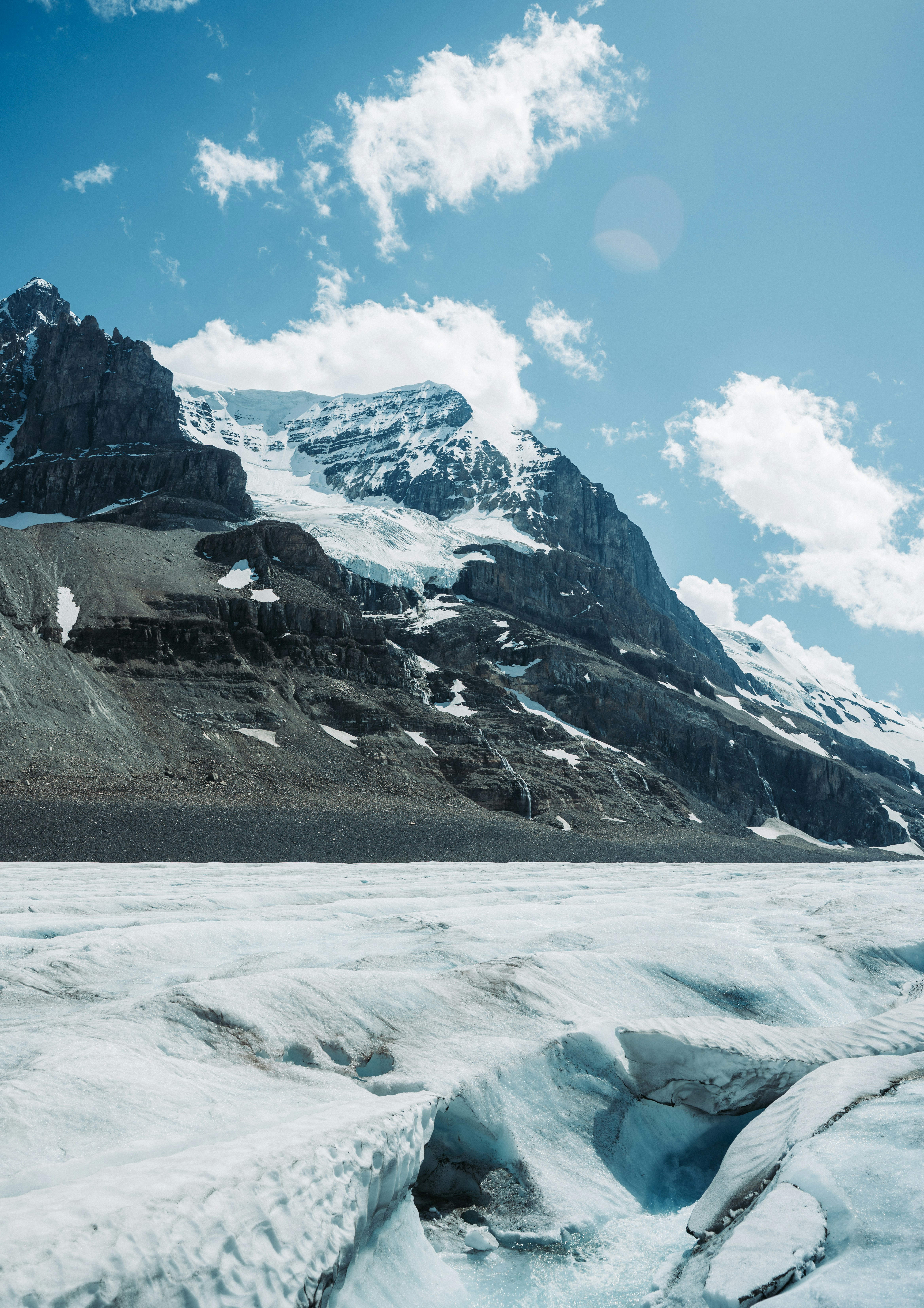 Snowy mountain range with a vast glacier below.
