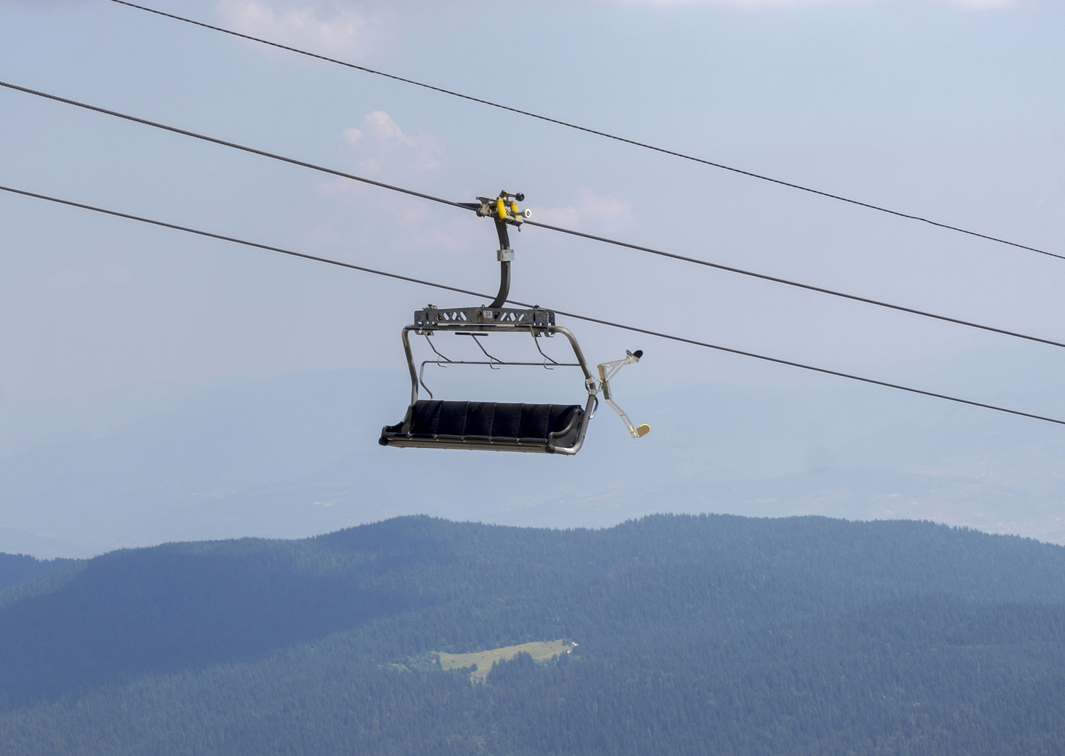 Ascending Above the Peaks: A Chairlift's Journey