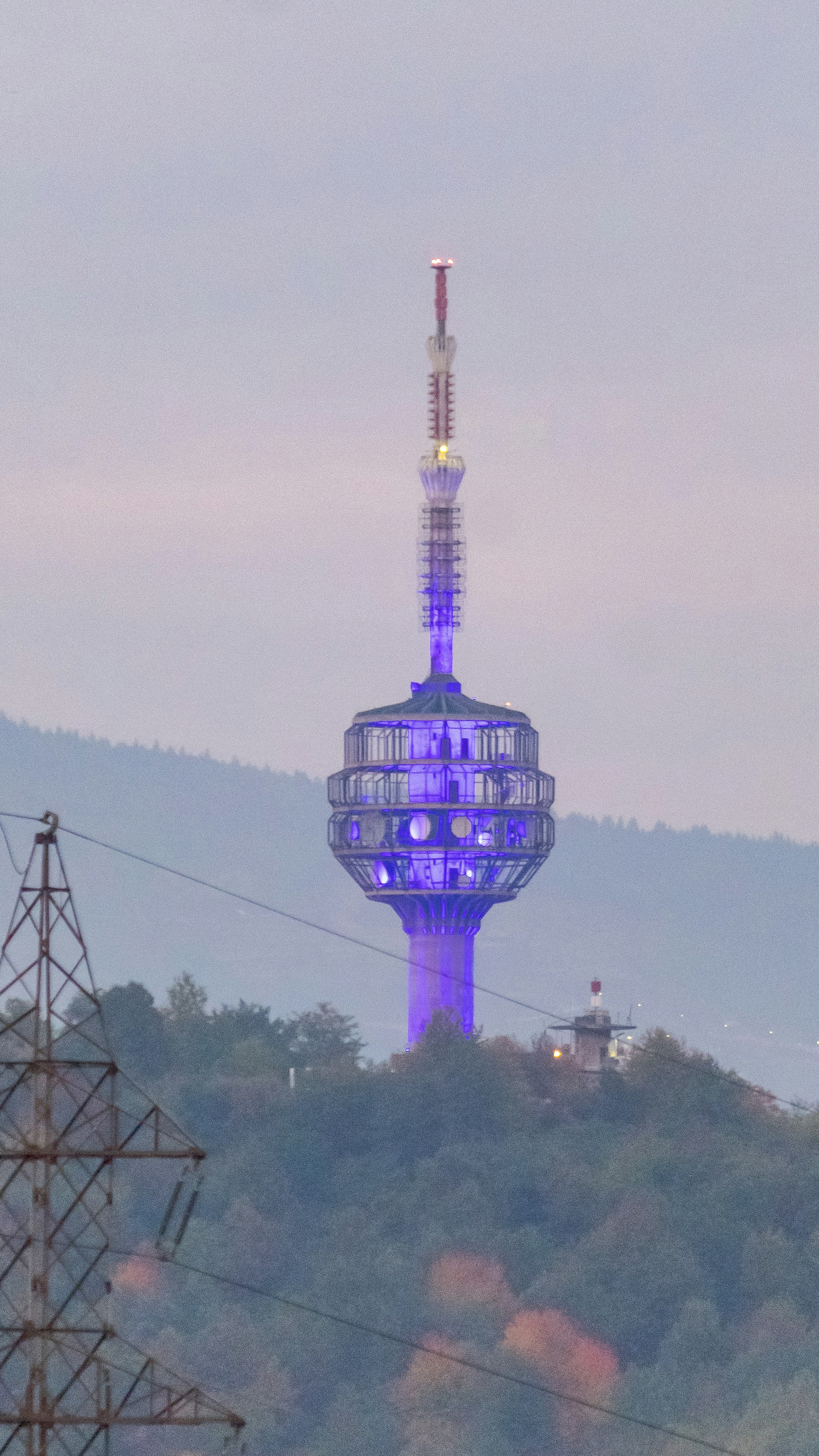 Tall tower illuminated with purple lights on a hill. photo – Free ...
