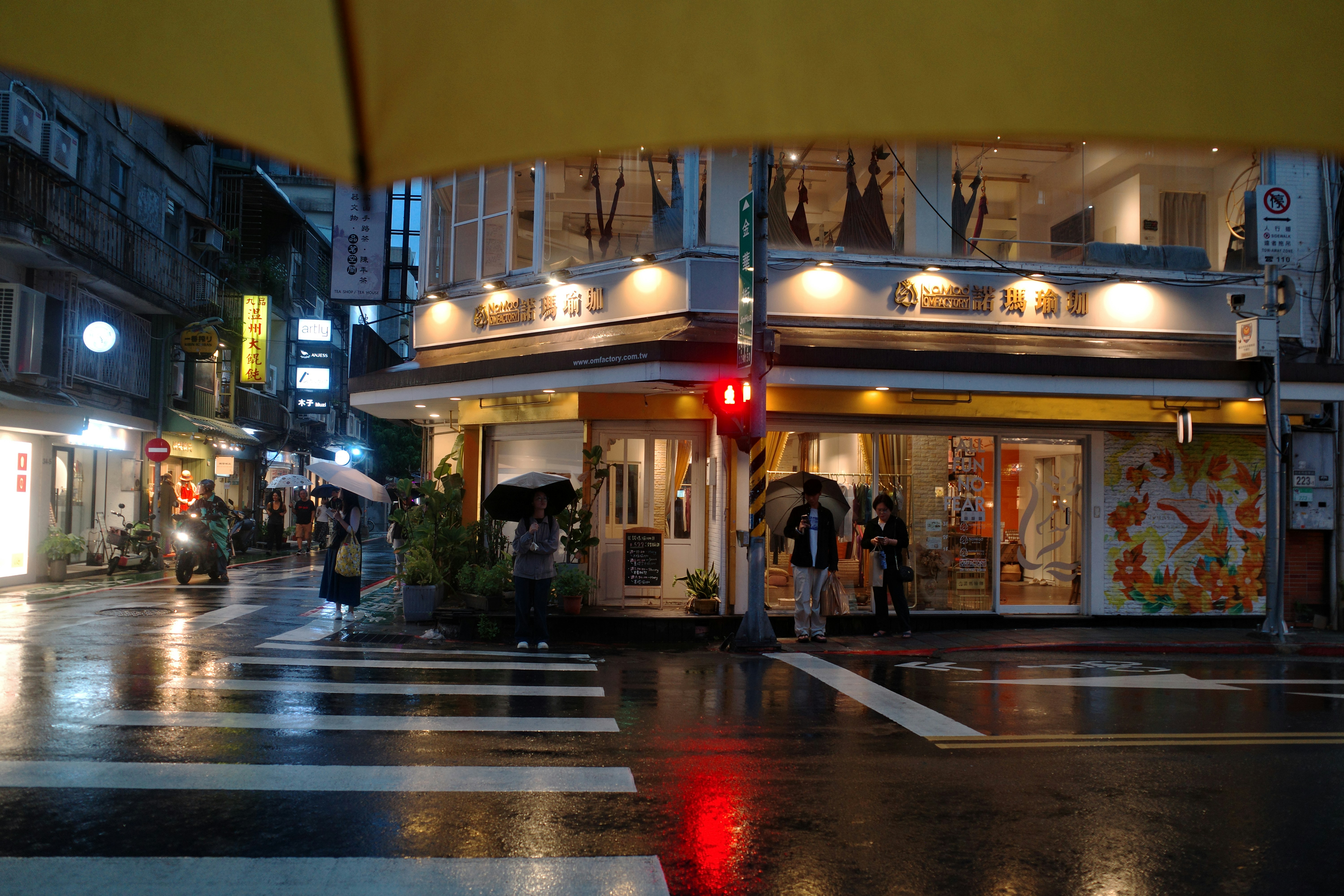 Rainy street scene with glowing shop windows