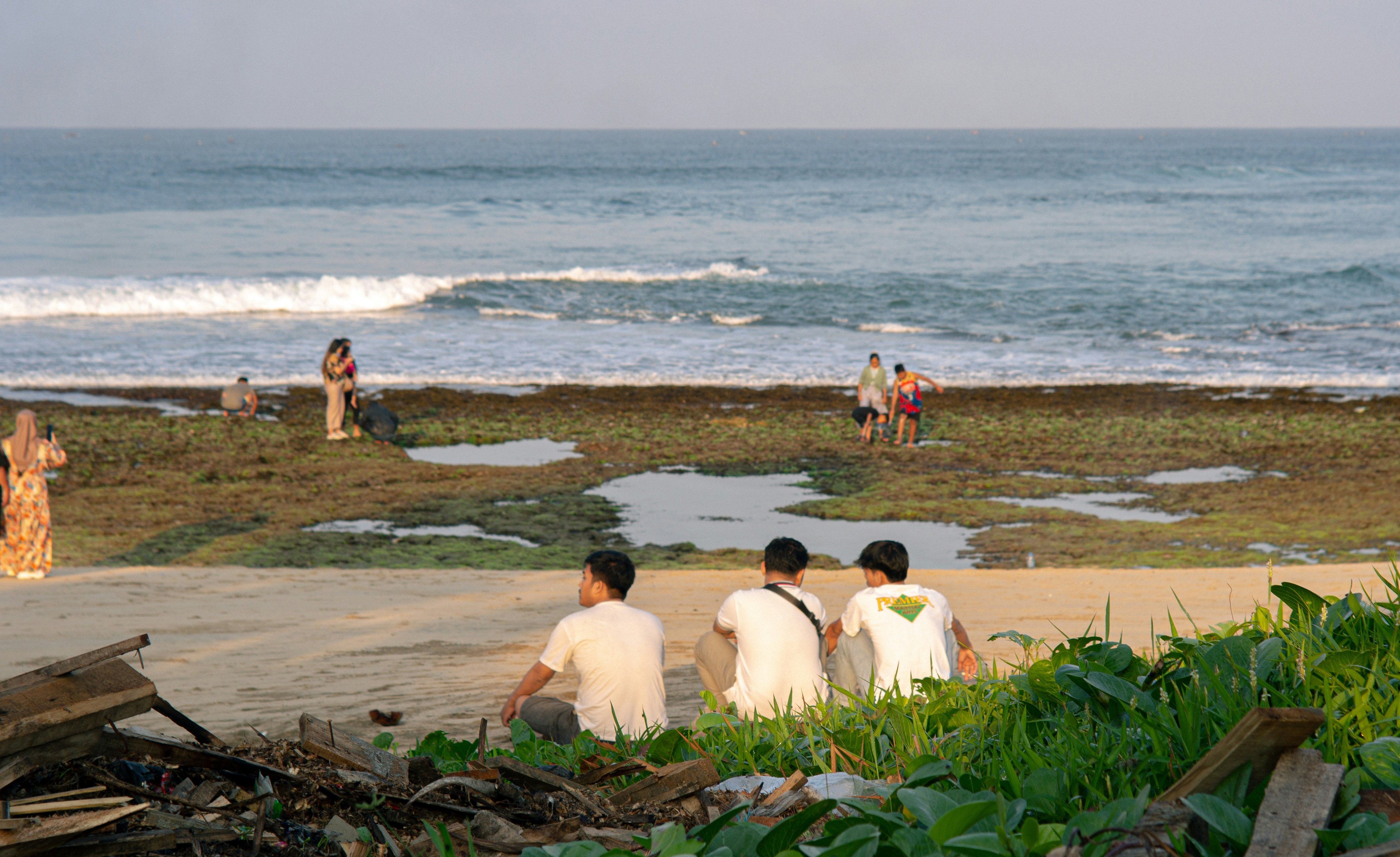 People relax on a beach near the ocean waves. photo – Free Beach Image ...