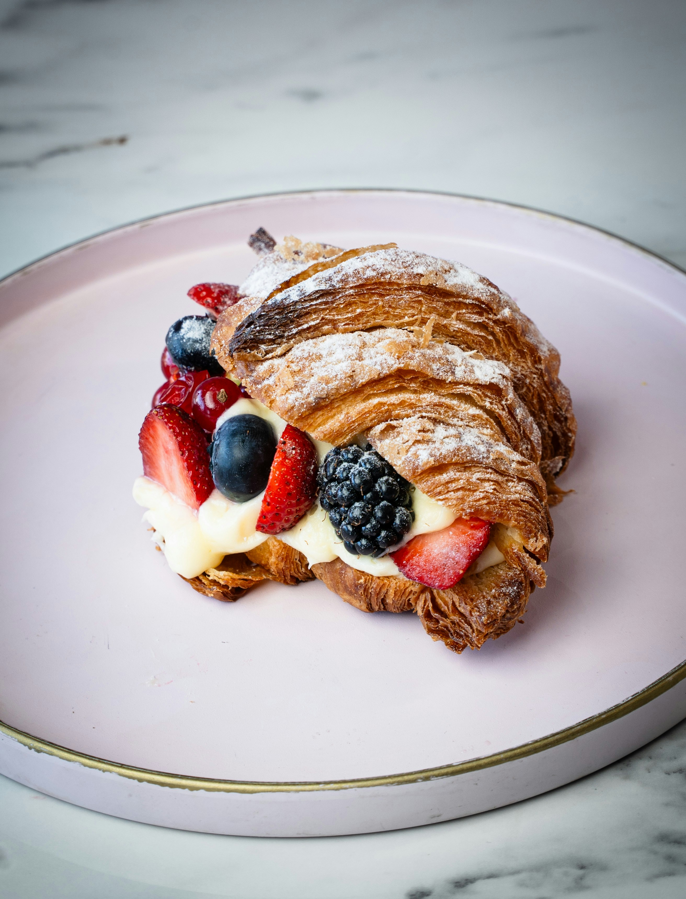 Croissant filled with cream and fresh berries