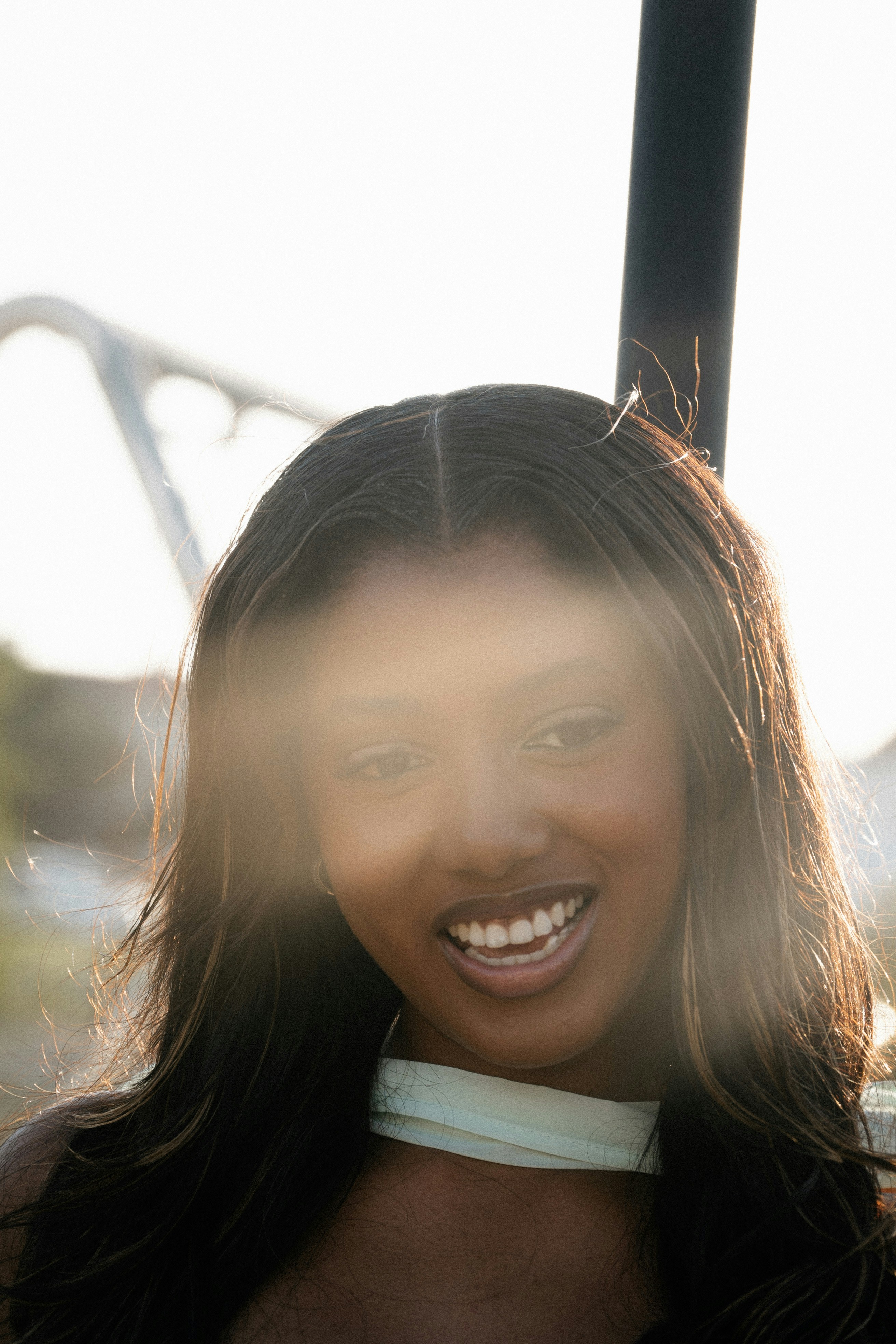 Smiling young woman with sunlight on her face.