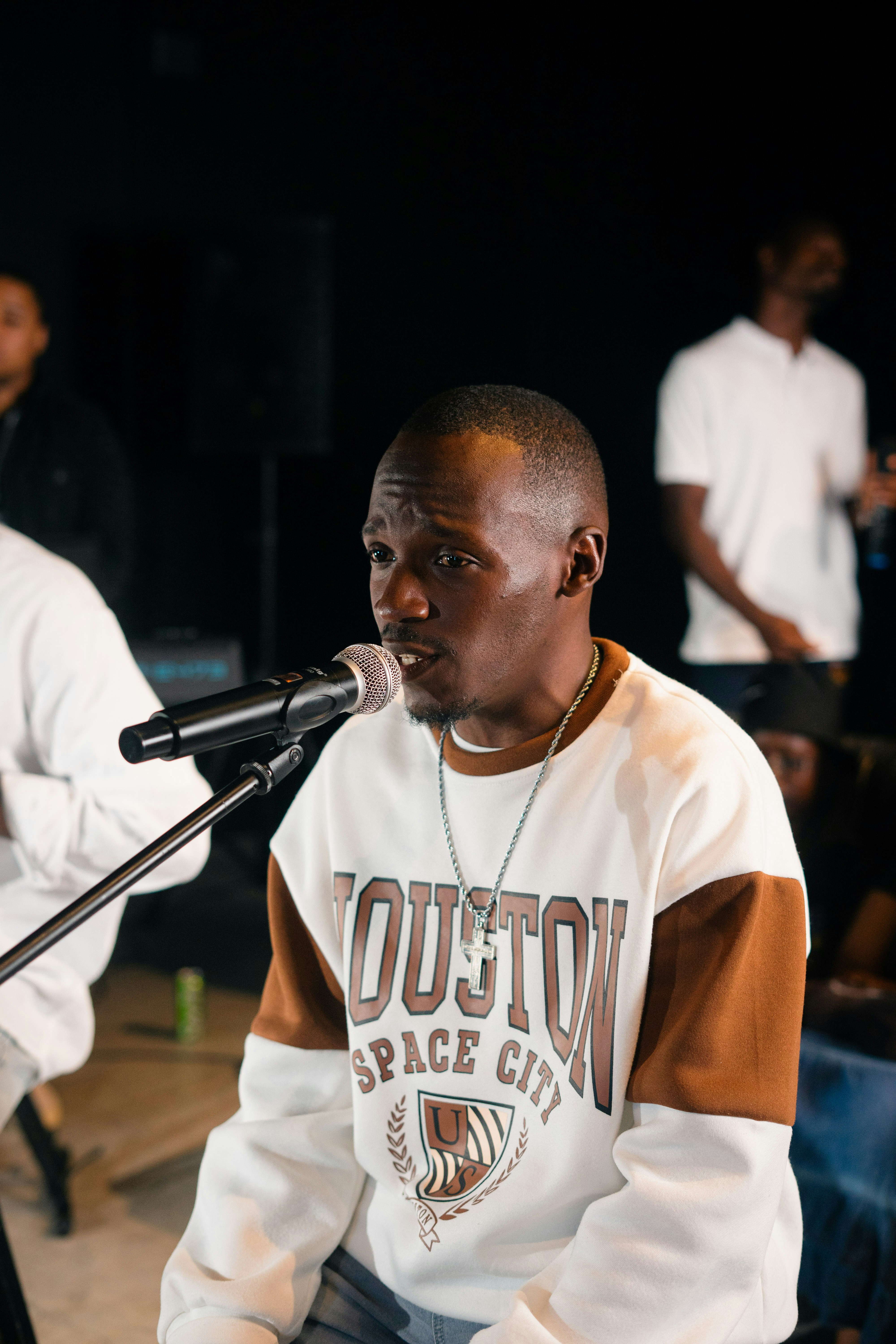 Man wearing a houston space city sweatshirt singing