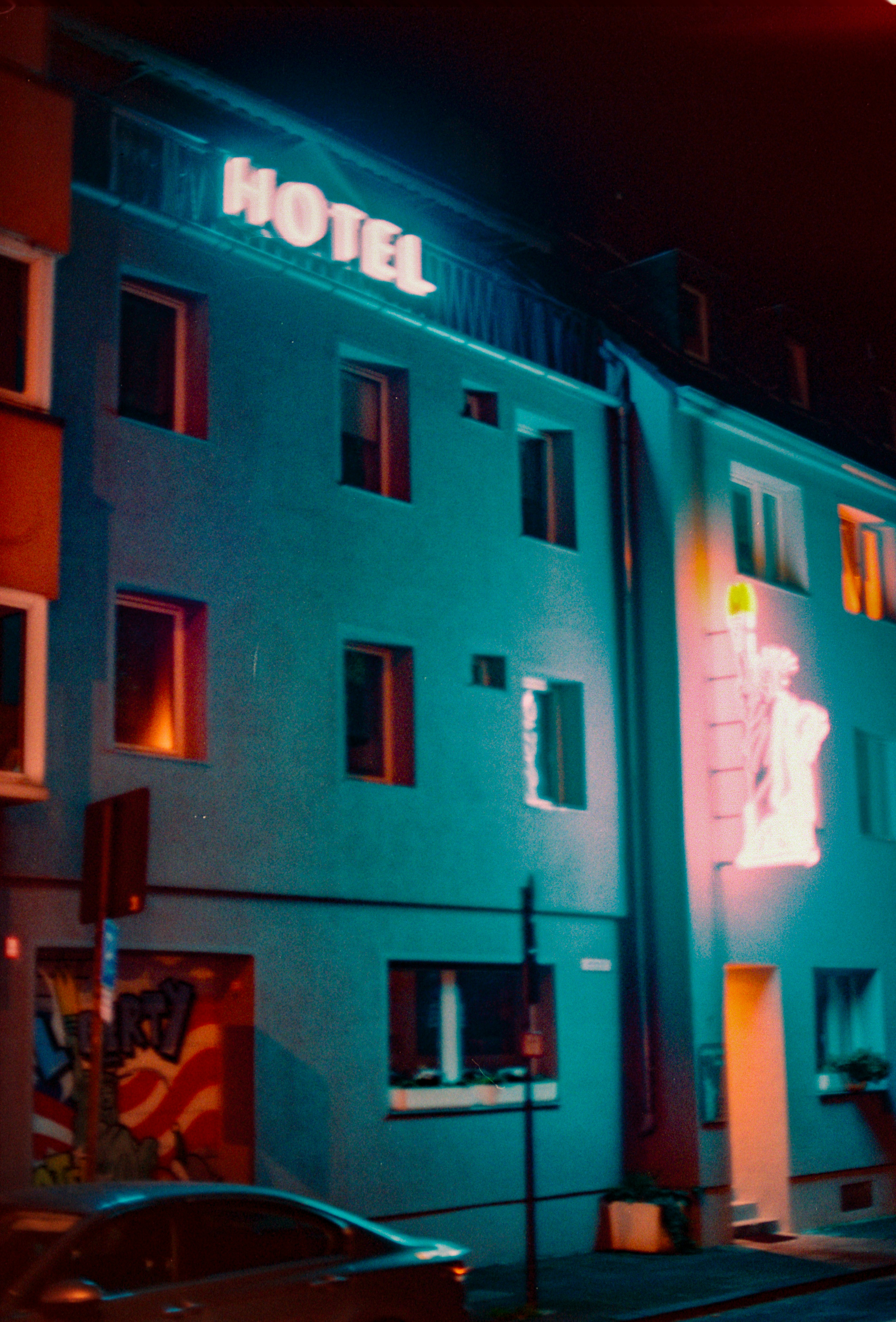 Hotel sign illuminated at night on building