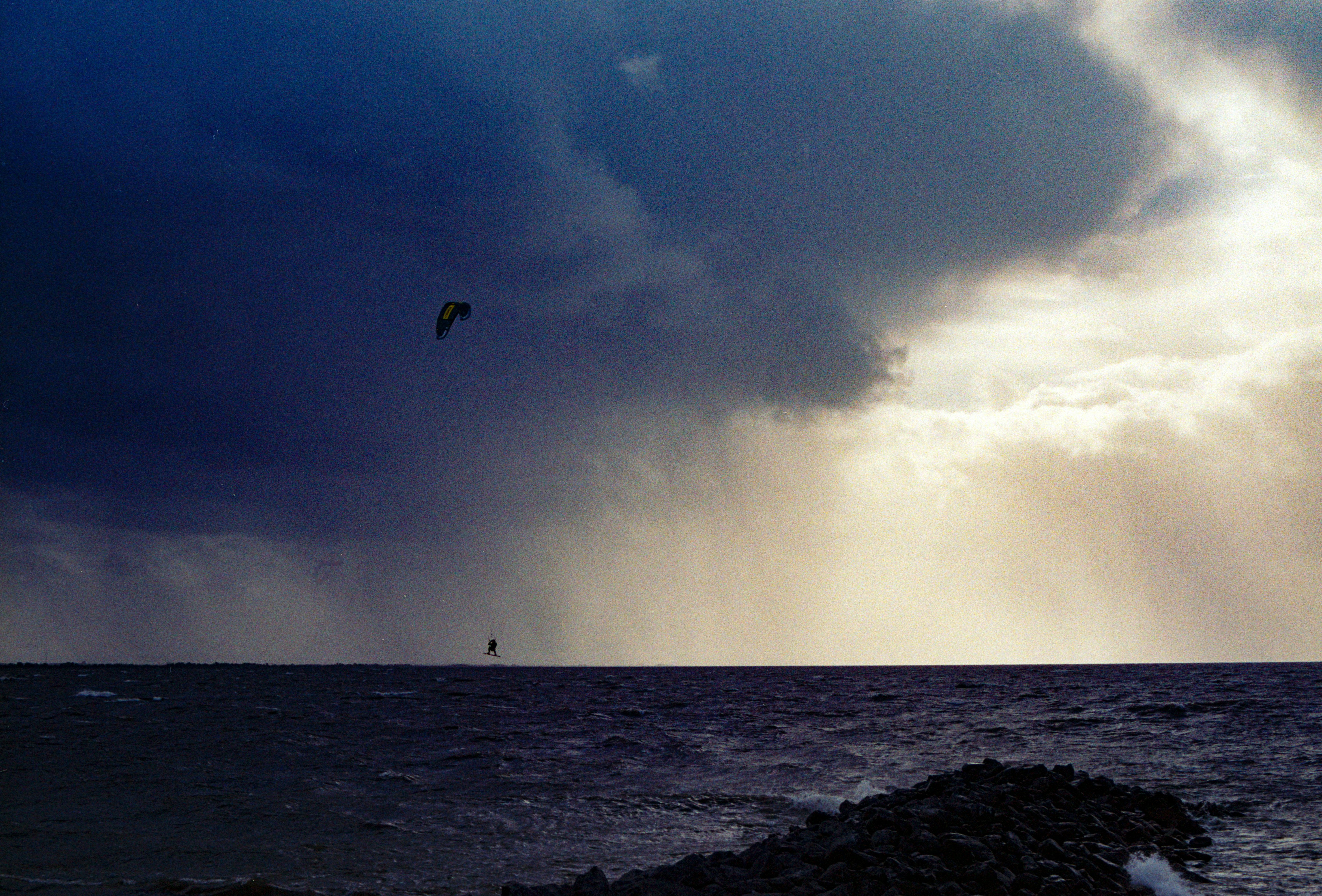 Dance of the Elements: Kite Surfer Against a Stormy Sky