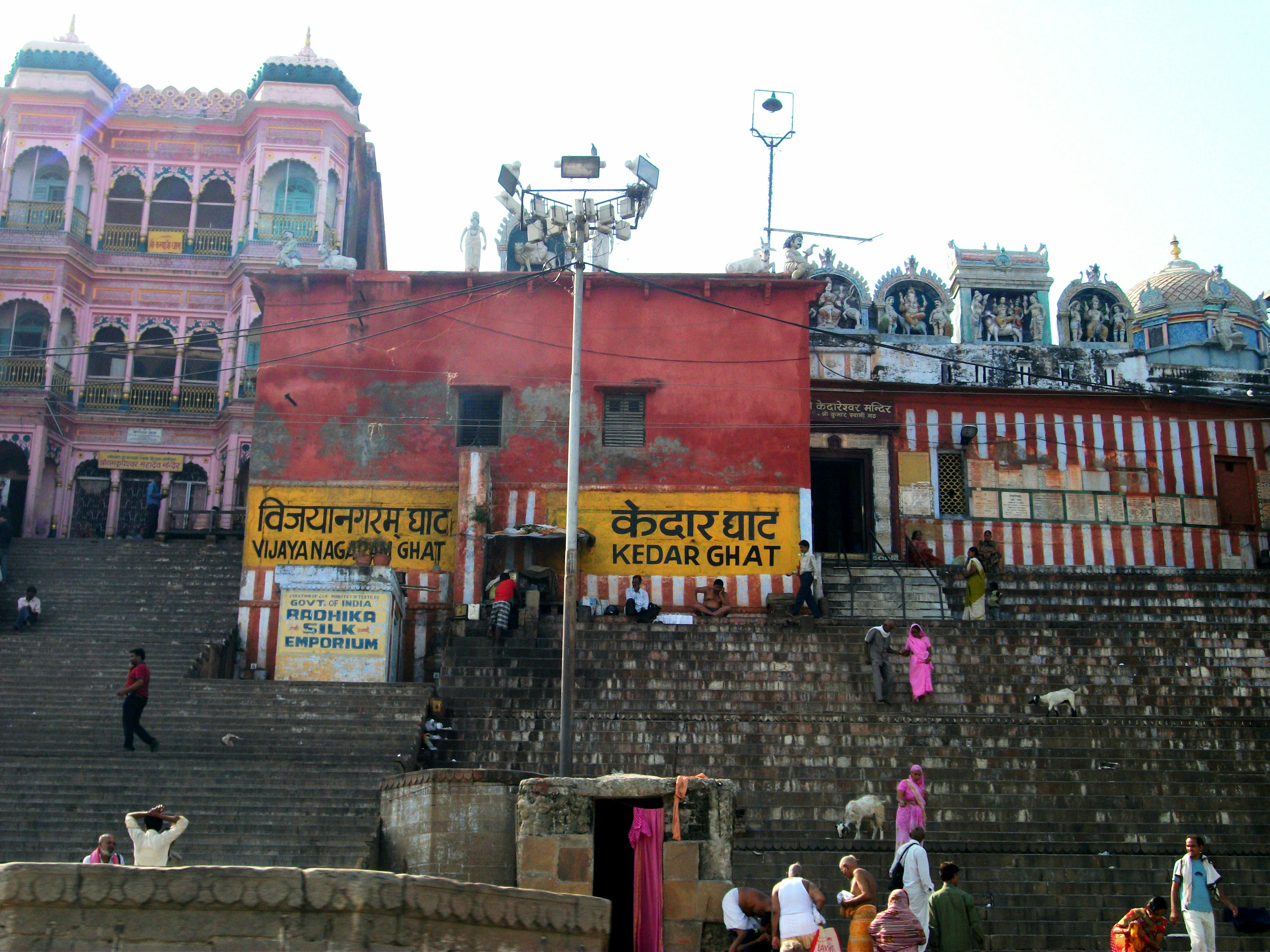 Varanasi is the first and last City on Earth. Every Day Many Pilgrims and Devotees from All Around the World Visit Varanasi (Khaasi). People Take Bath on the Ghats of Varanasi in the Holy River Ganga and Worship the Destroyer Shiva. Kala Bhairav is the Protector of this City. Ganga Devi, The Mighty Godess Force of Sacred Water from Heaven to Earth. To Control Her Flow Smoothly to Earth The God of Destroyer Shiva, kept Ganga Devi on his Head and Opened a Small Hair Lock in Which the Flow of Ganga Devi was controlled smoothly to earth. Ganga Devi is considered the Holy River of Earth. | People on steps leading to kedar ghat in india