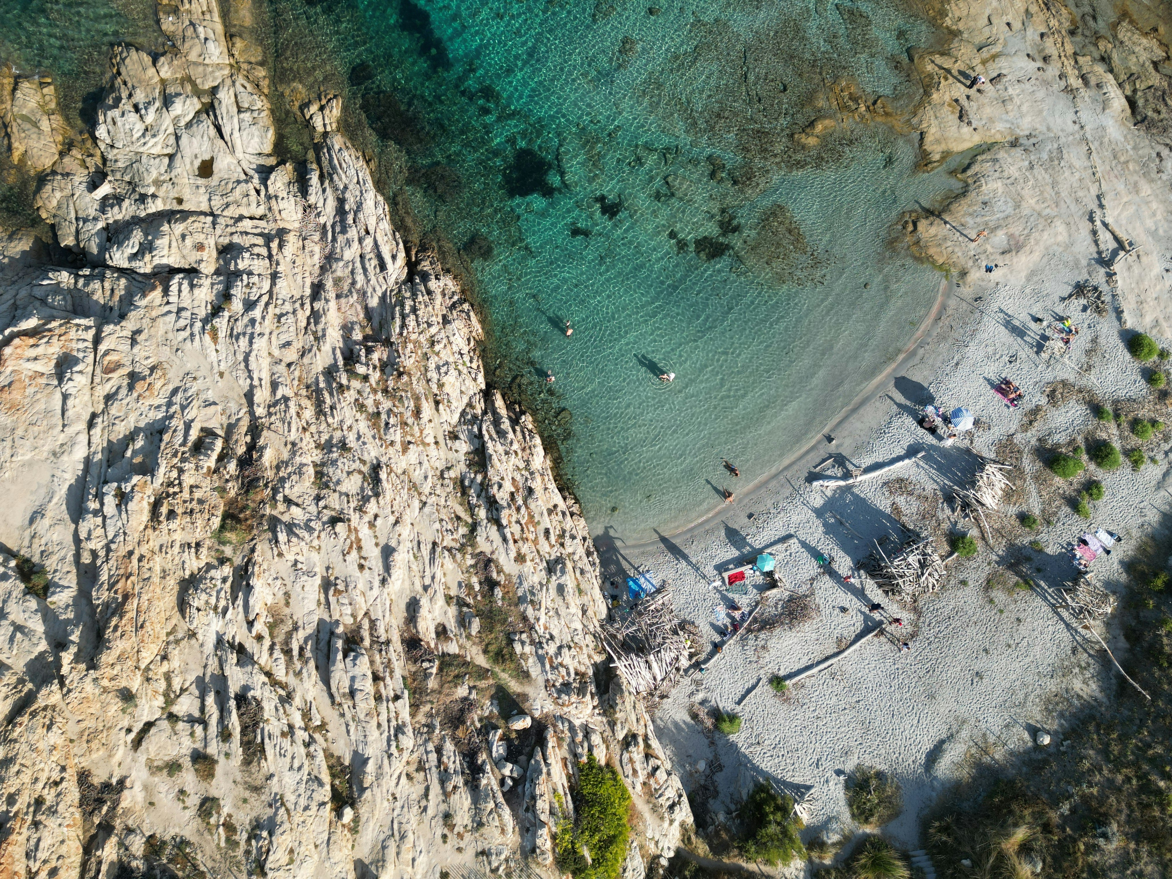 Aerial view of a rocky coastline and sandy beach.