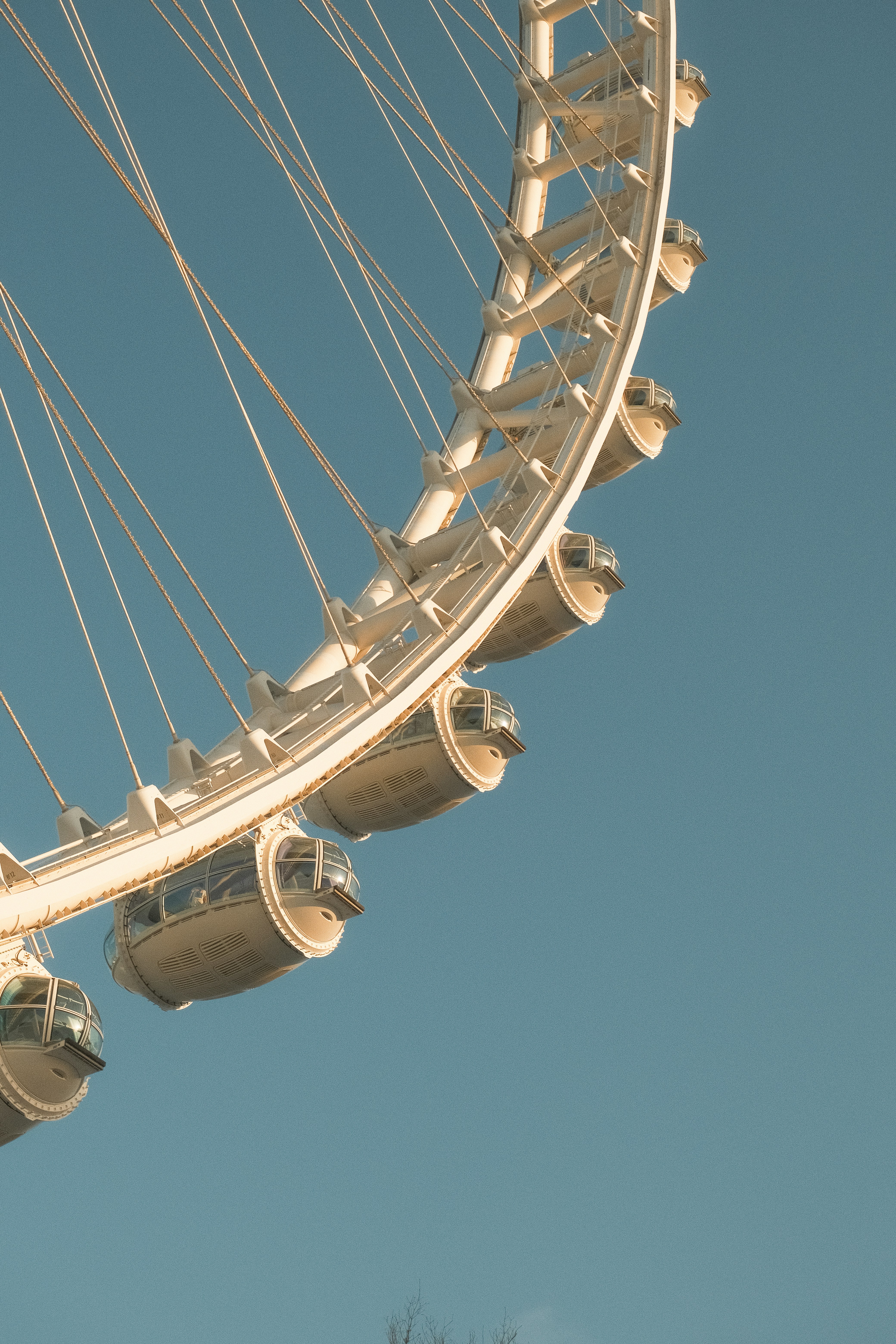 Close-up of a ferris wheel against a clear blue sky