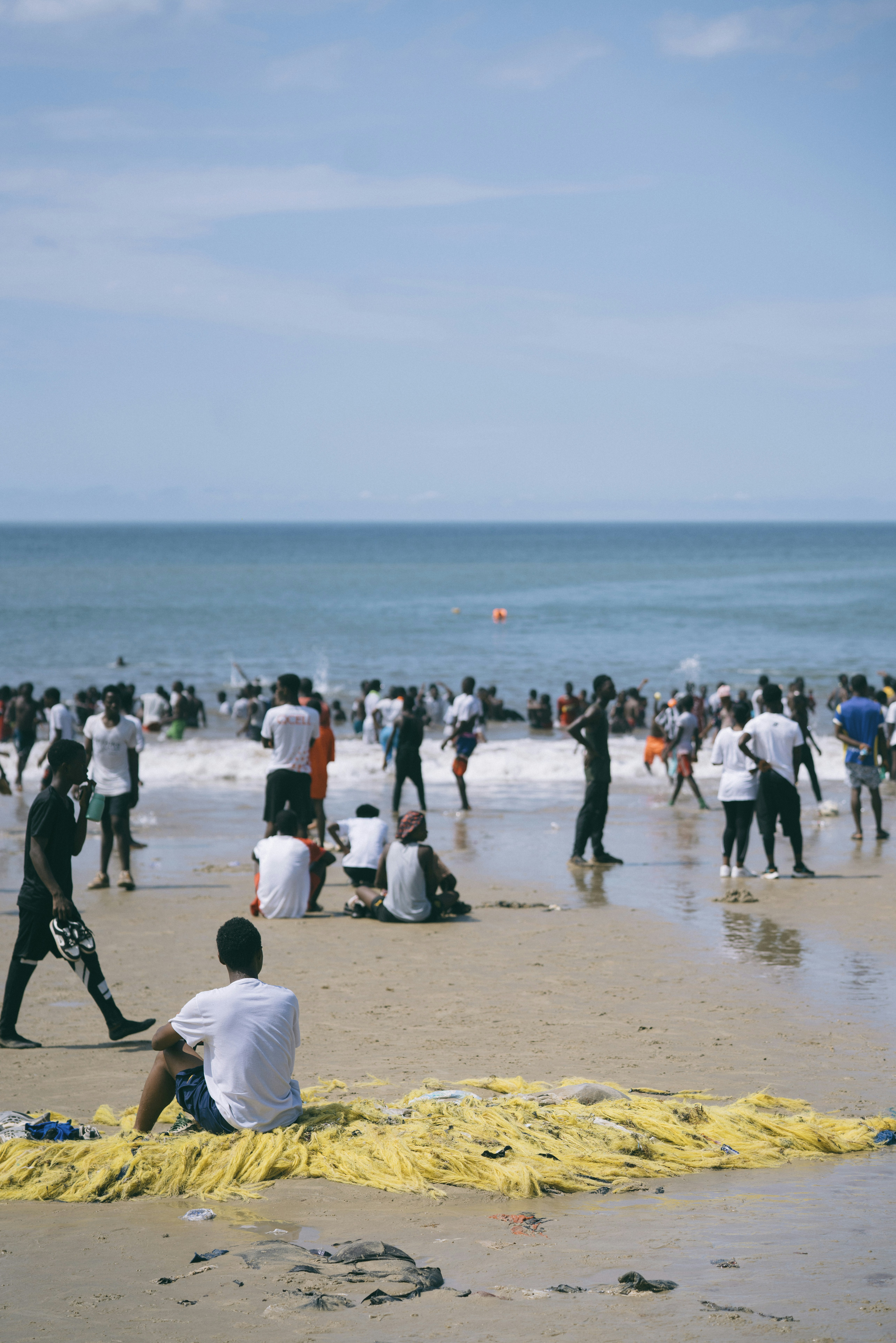 Horizon Huddle: A Busy Beach Day Framed by a Distant Buoy