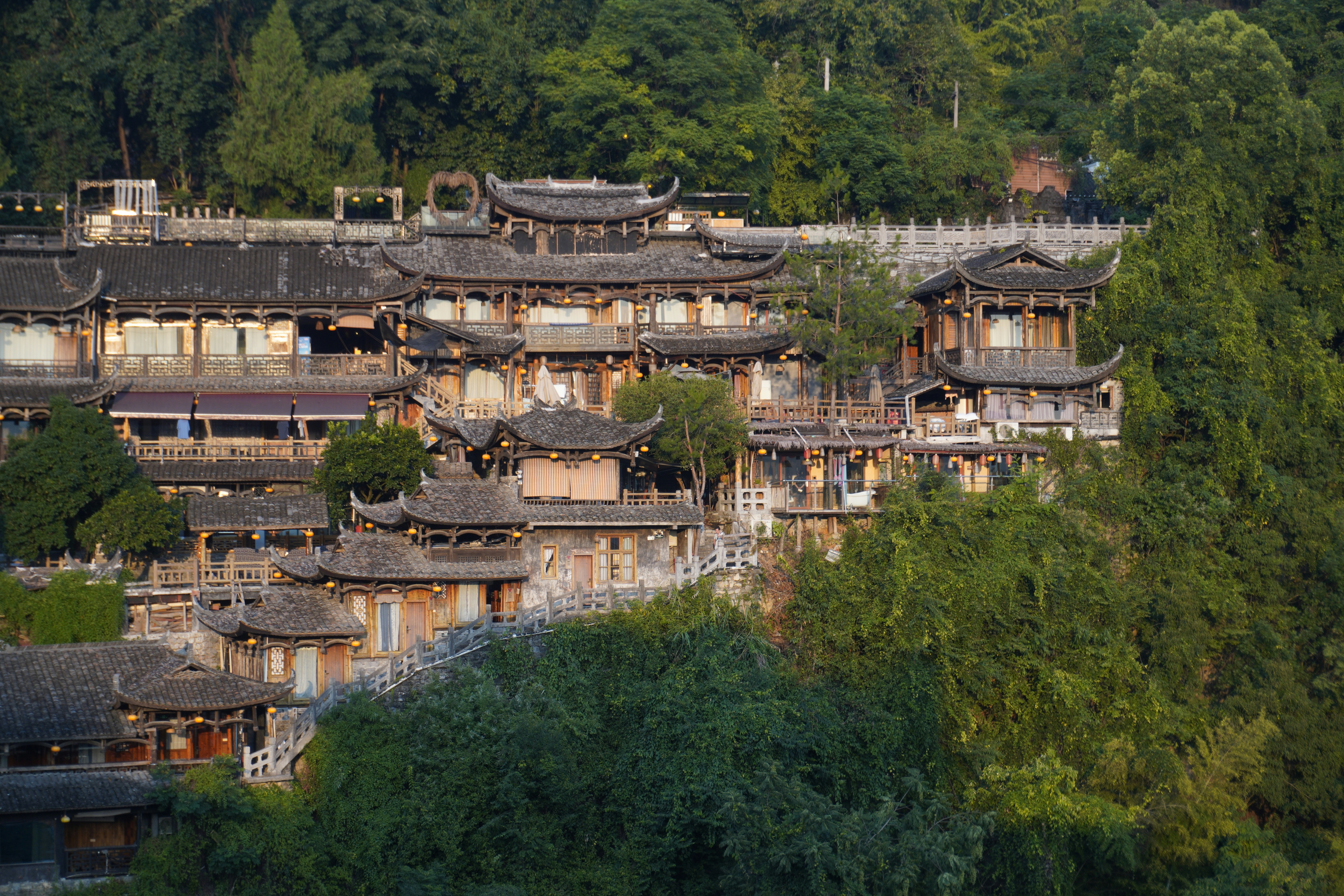 Traditional chinese village nestled in lush green hills.