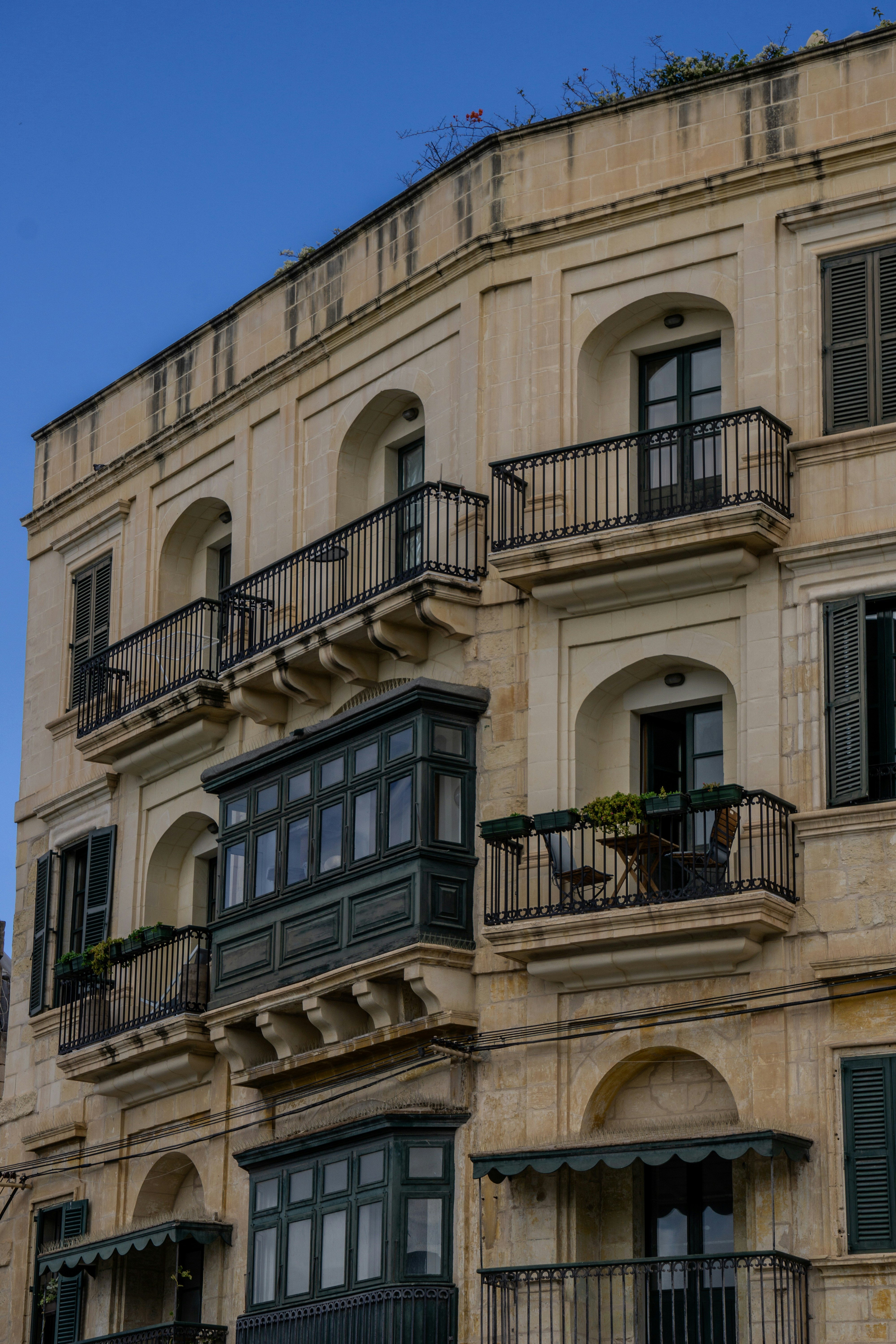Ornate balconies on a pale stone building