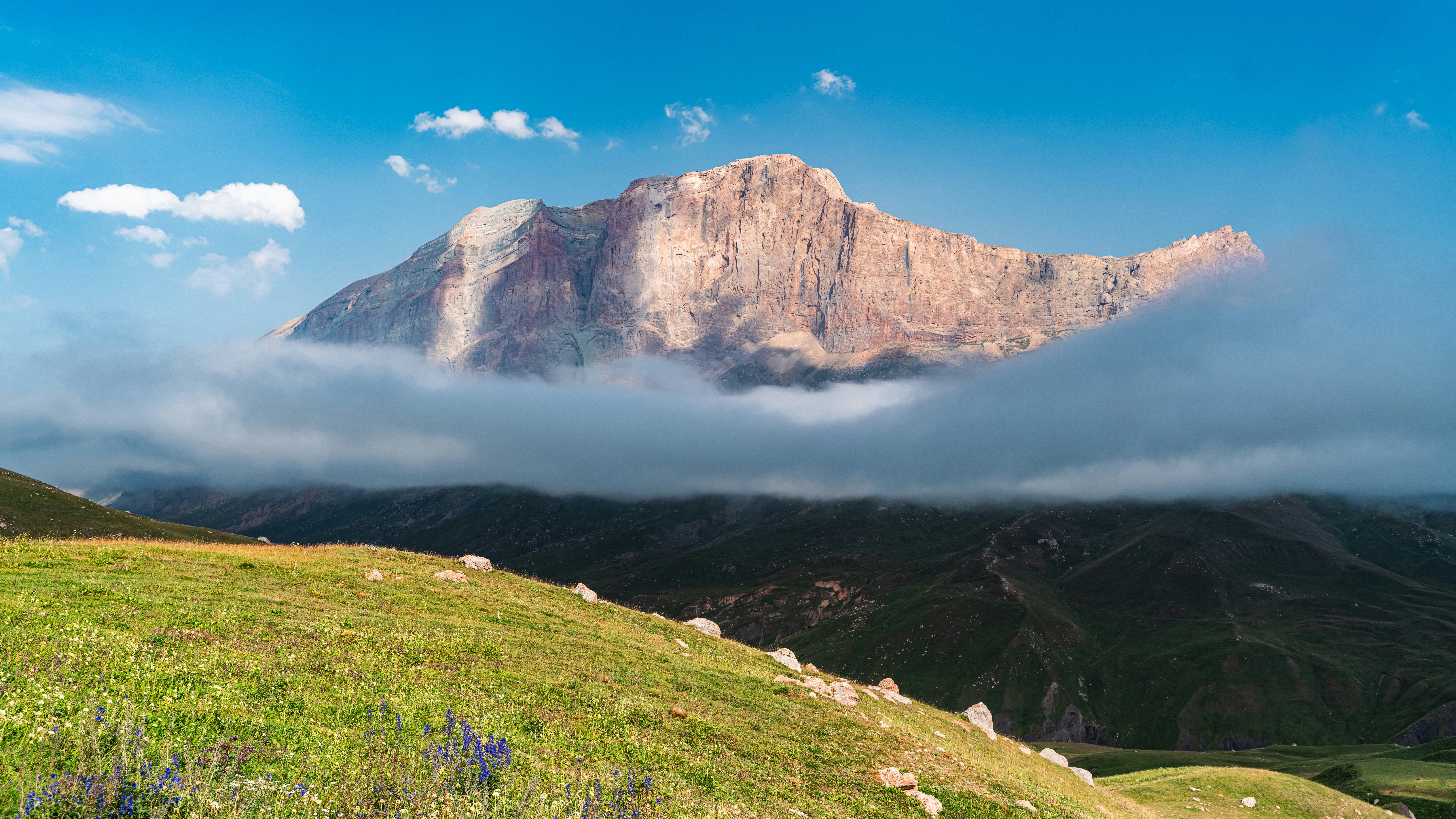 Veil of Clouds Over Majestic Peaks