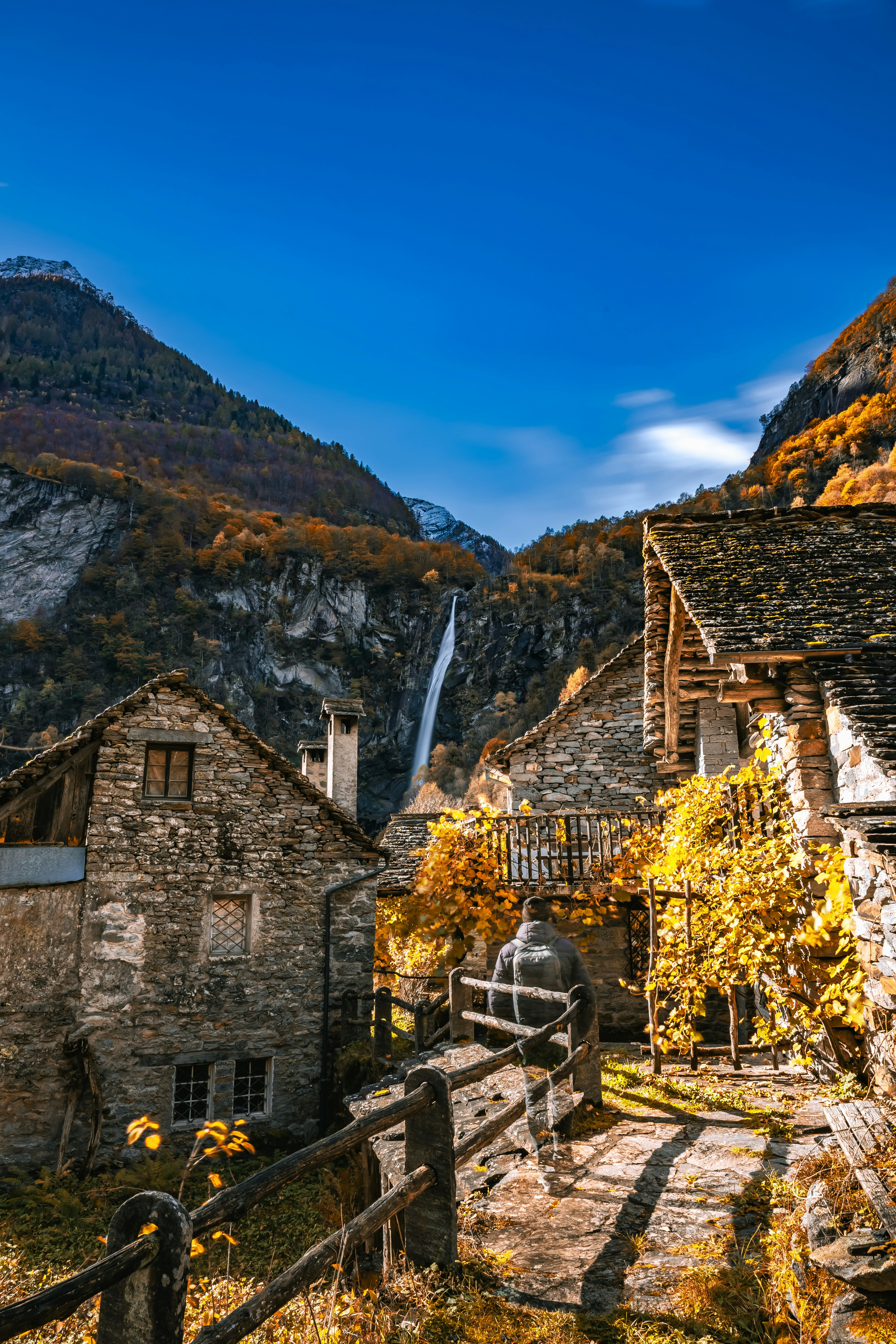 Autumn Cascade Over a Stone Village