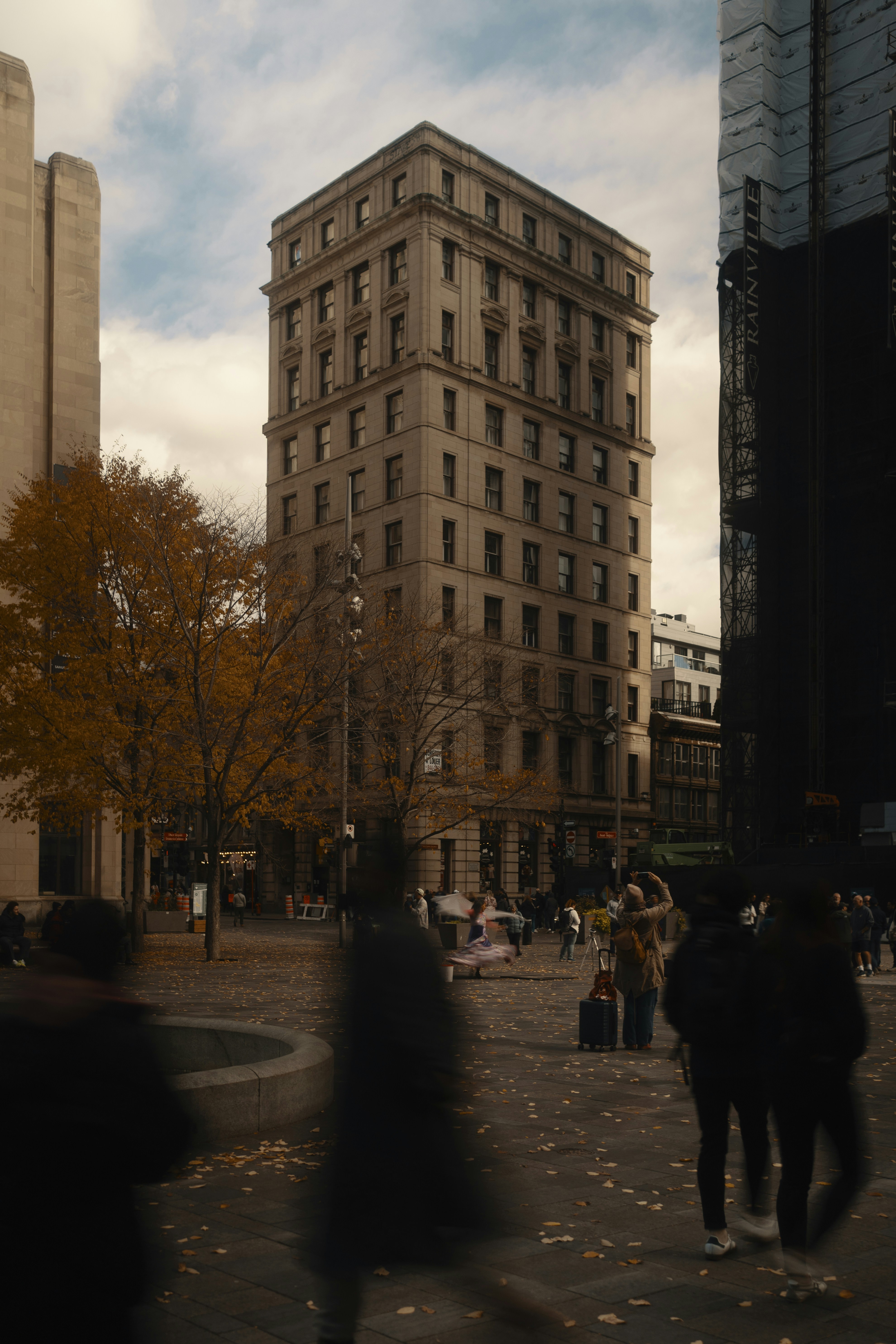 Tall building with people walking on street