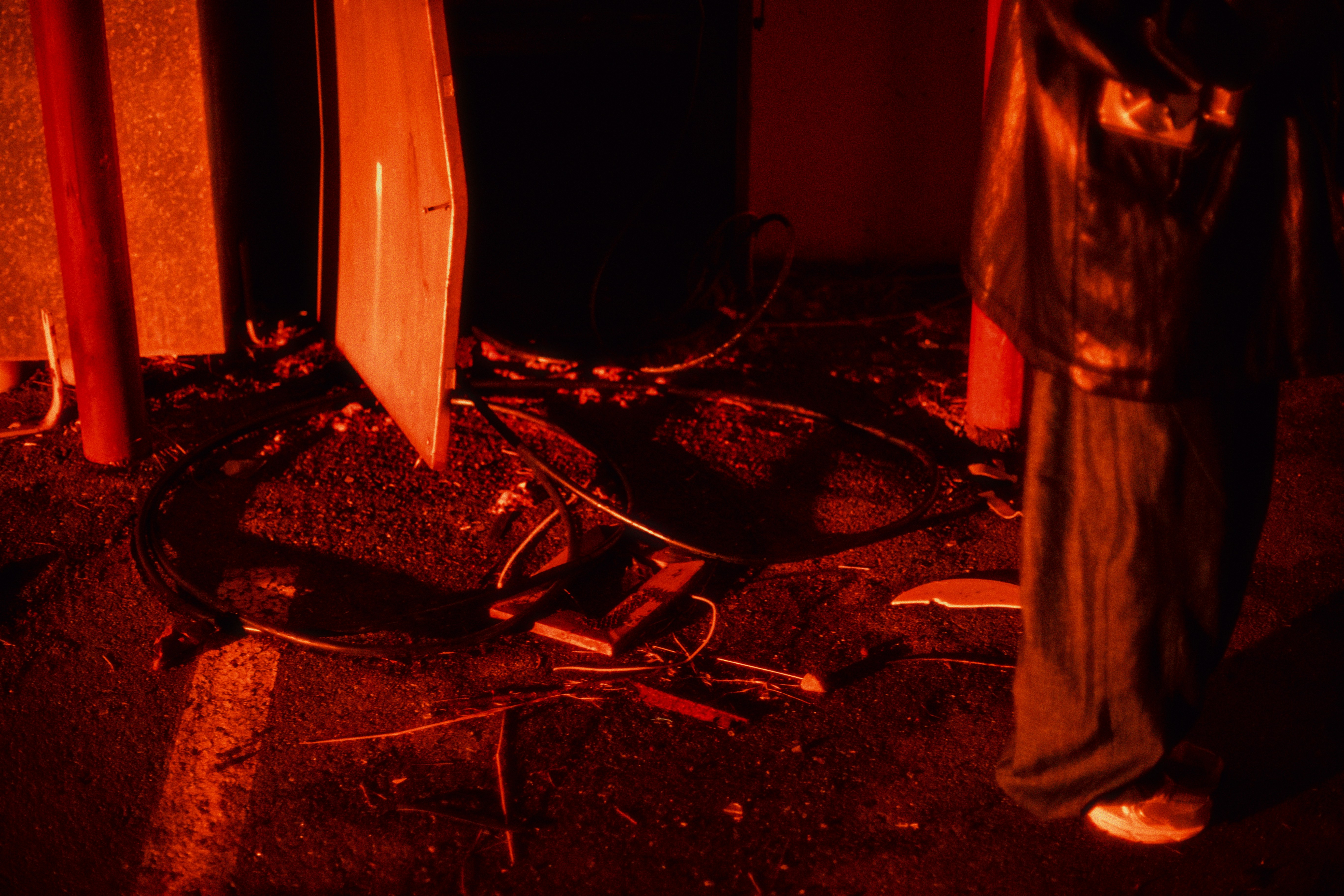 Damaged street furniture with debris and person