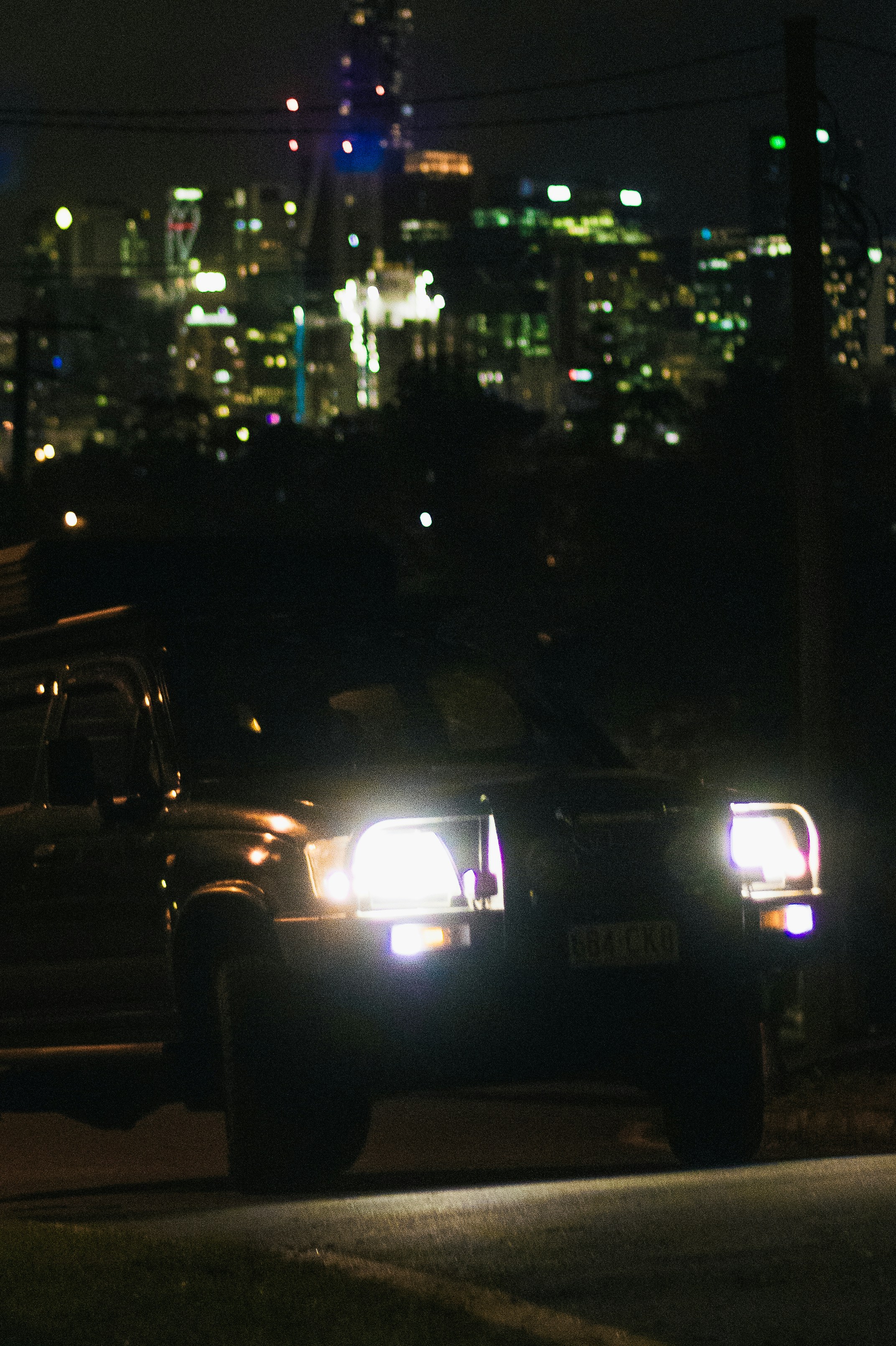 Urban Night Odyssey: A Vehicle's Journey Through City Lights