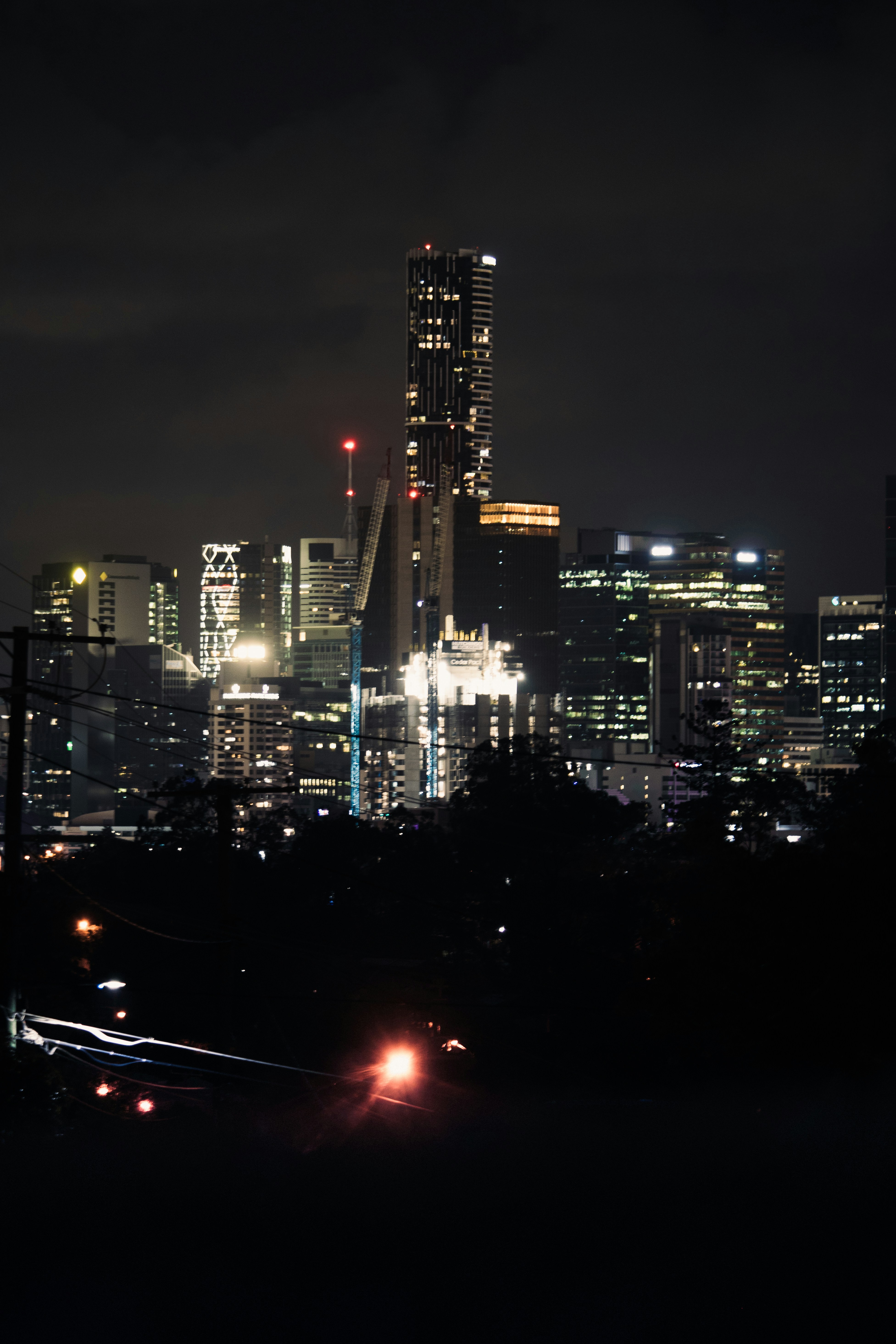 City skyline illuminated at night with tall buildings.