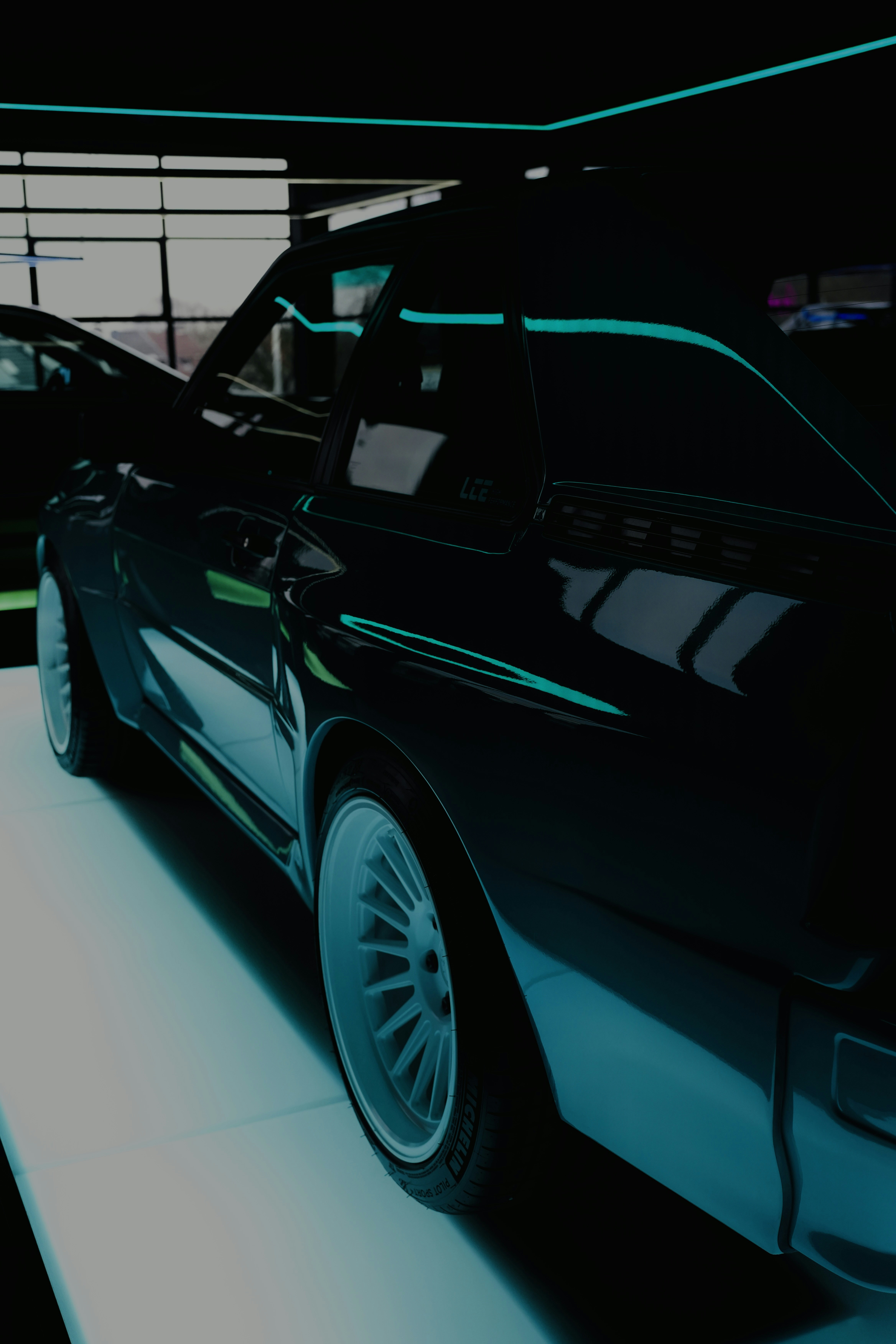 Black vintage car with neon blue accents