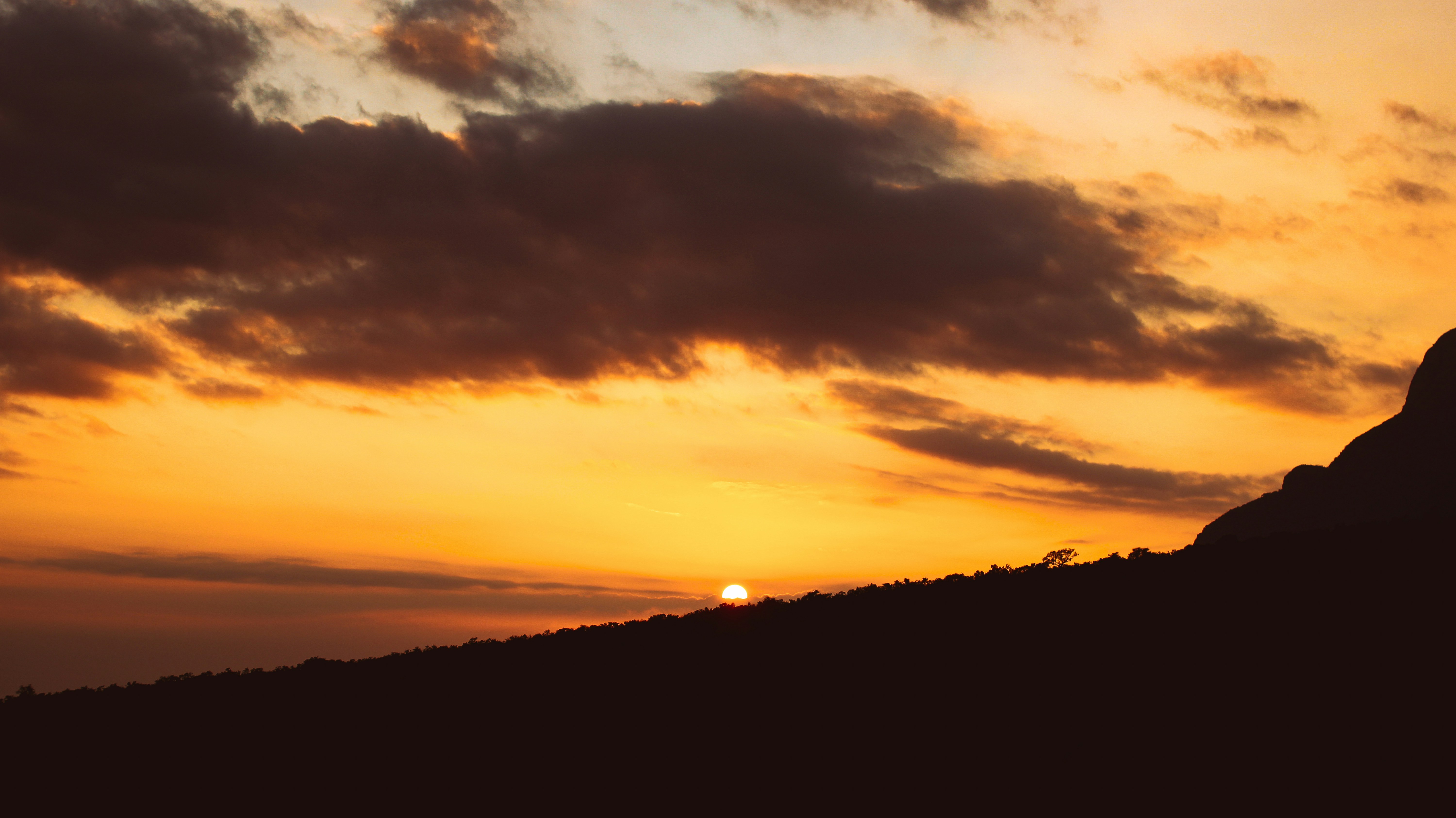 Sunset over a silhouetted mountain range
