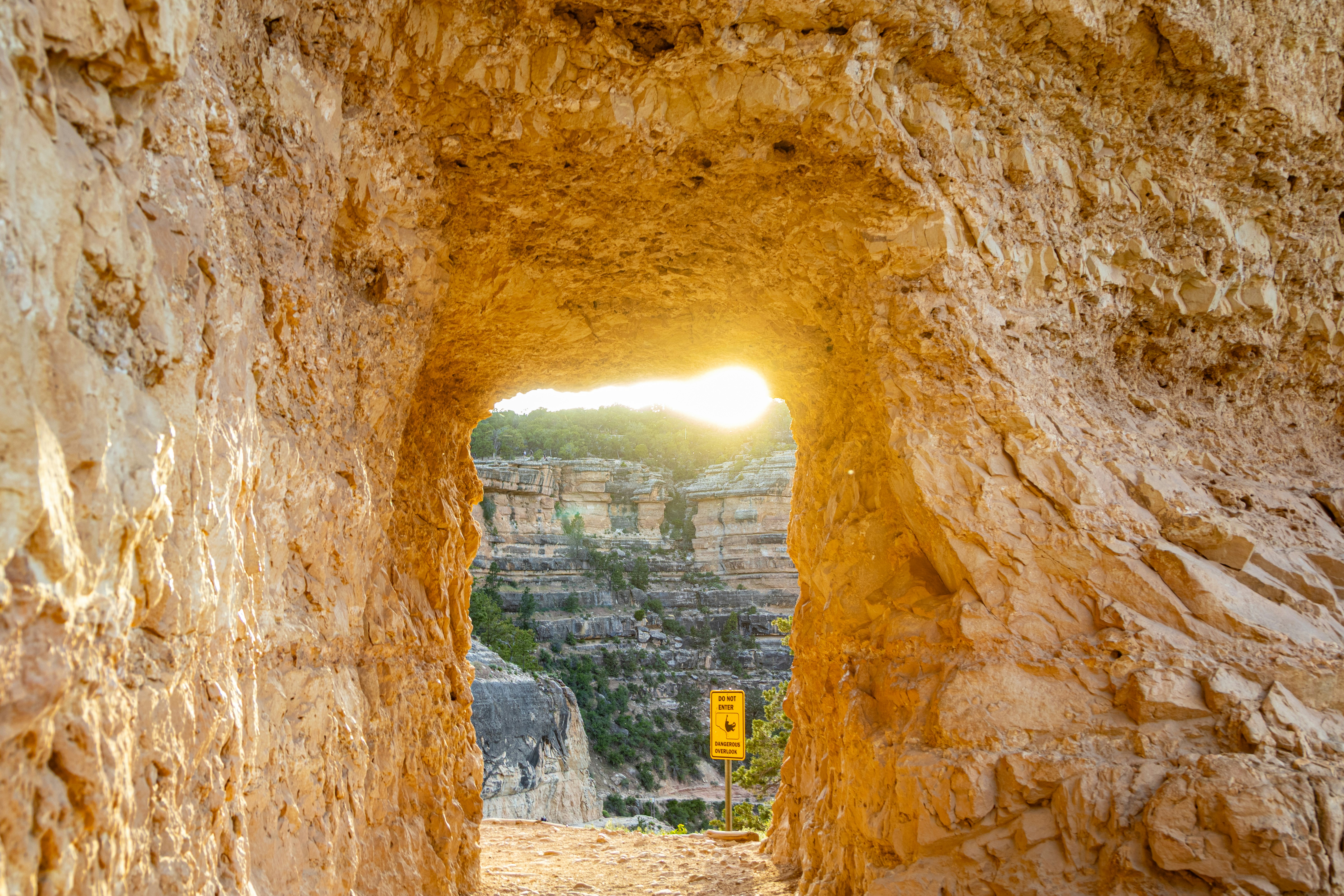 Sunlit Portal Through a Weathered Arch to a Distant Canyon