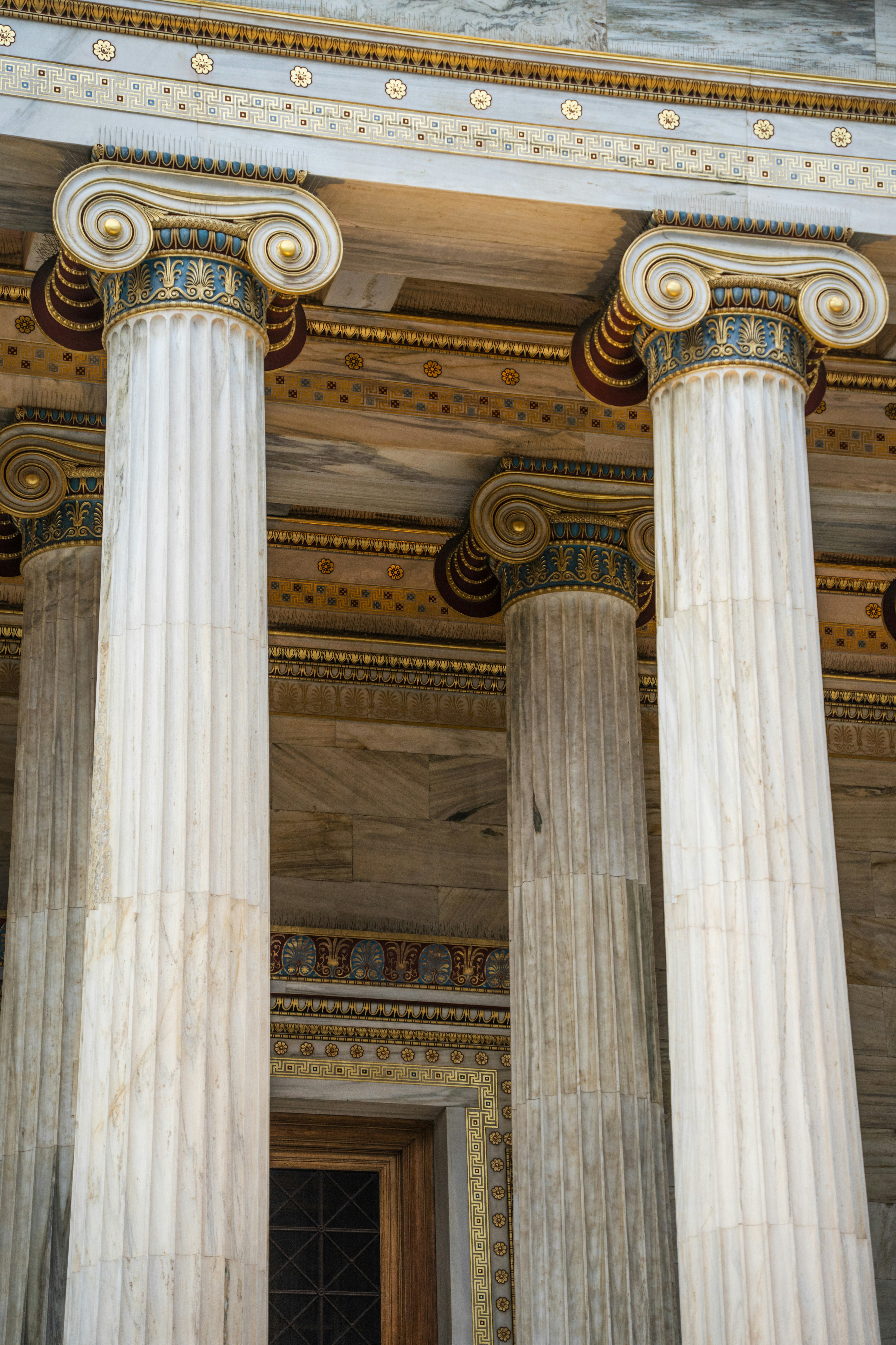 Intricately designed Corinthian columns adorned with vibrant detailing, showcasing classical architectural elegance.