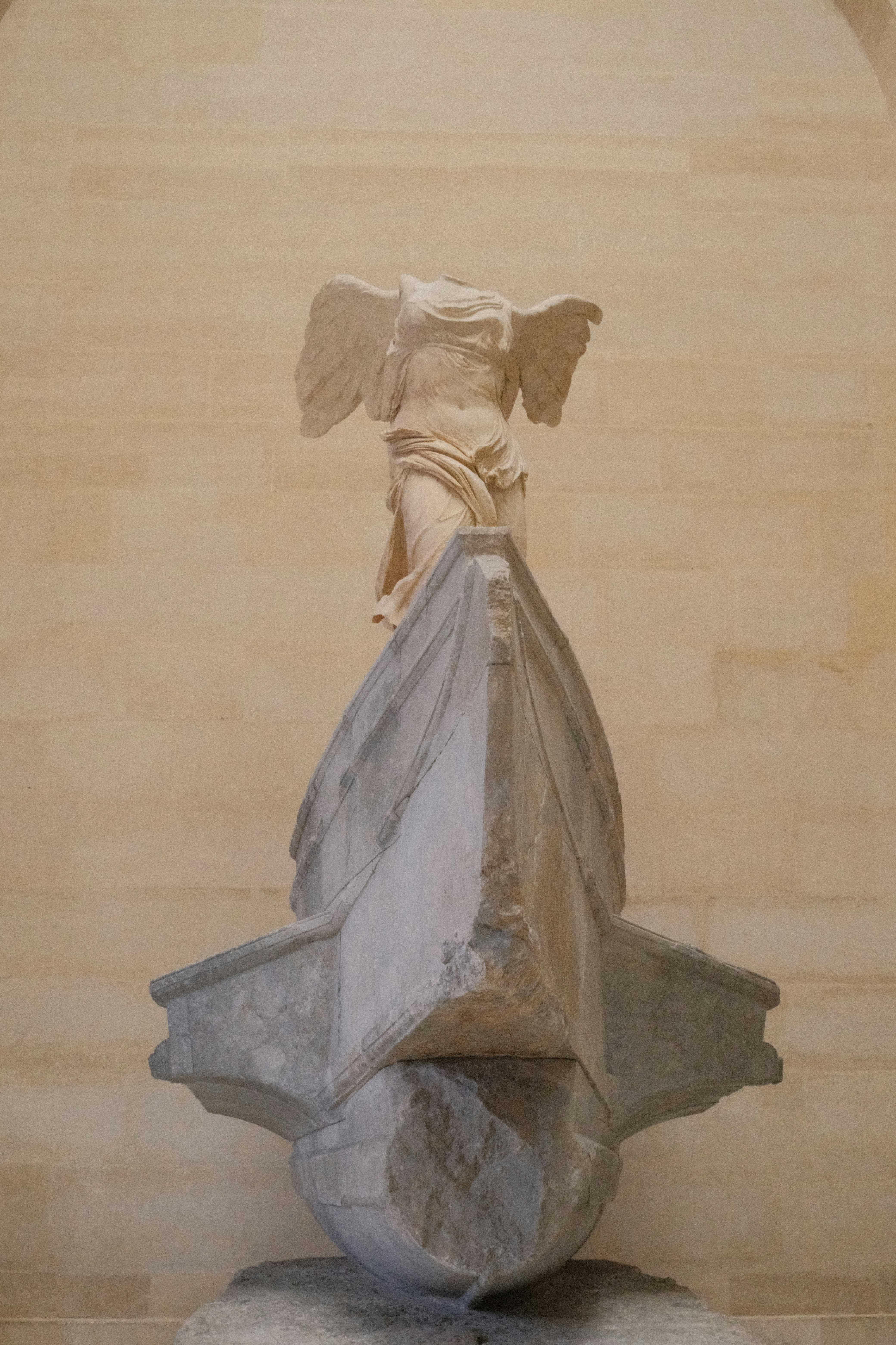 Winged statue atop a stone ship base photo – Free Greek mythology Image ...