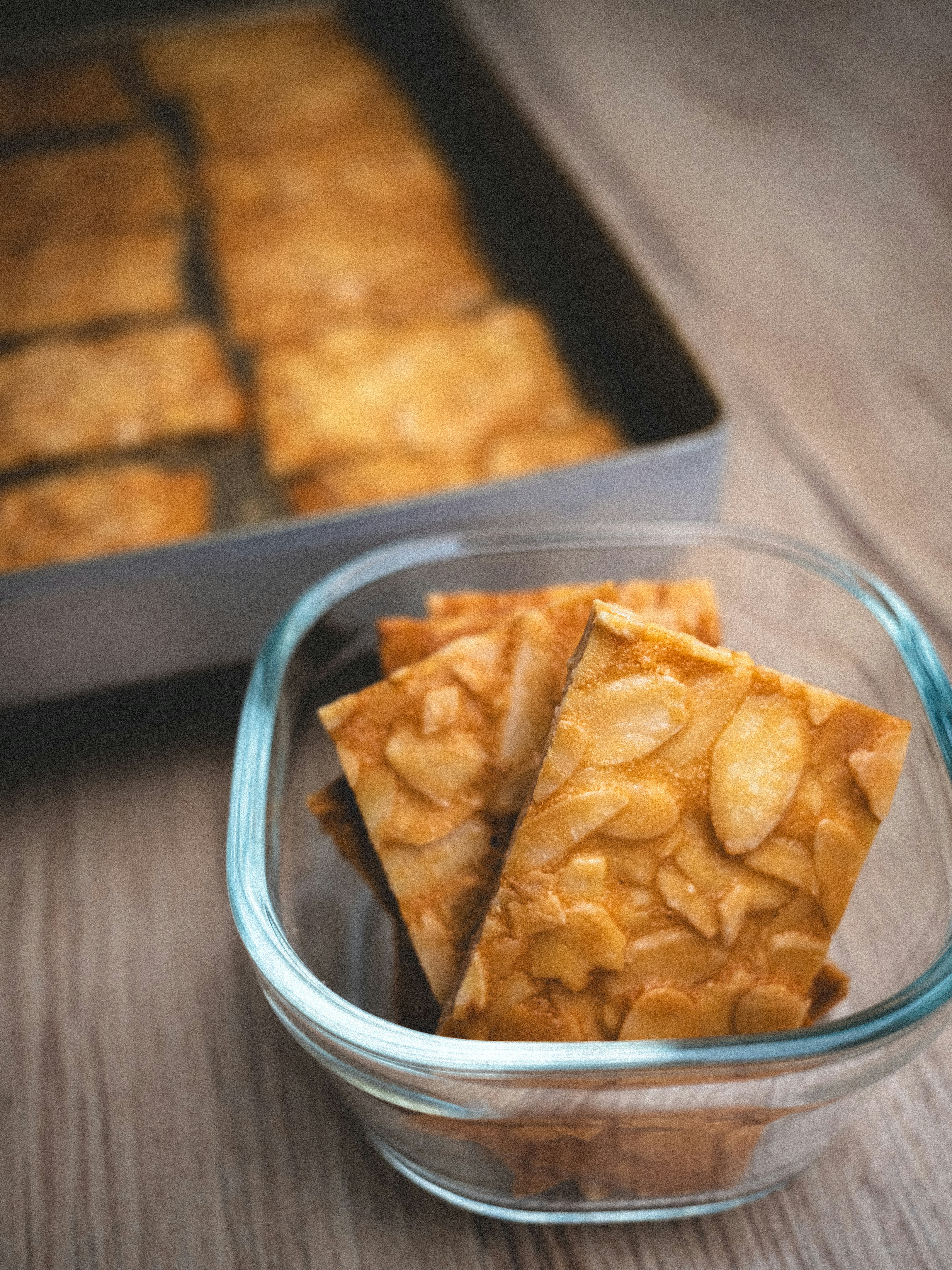 Almond cookies in a glass bowl and baking tray