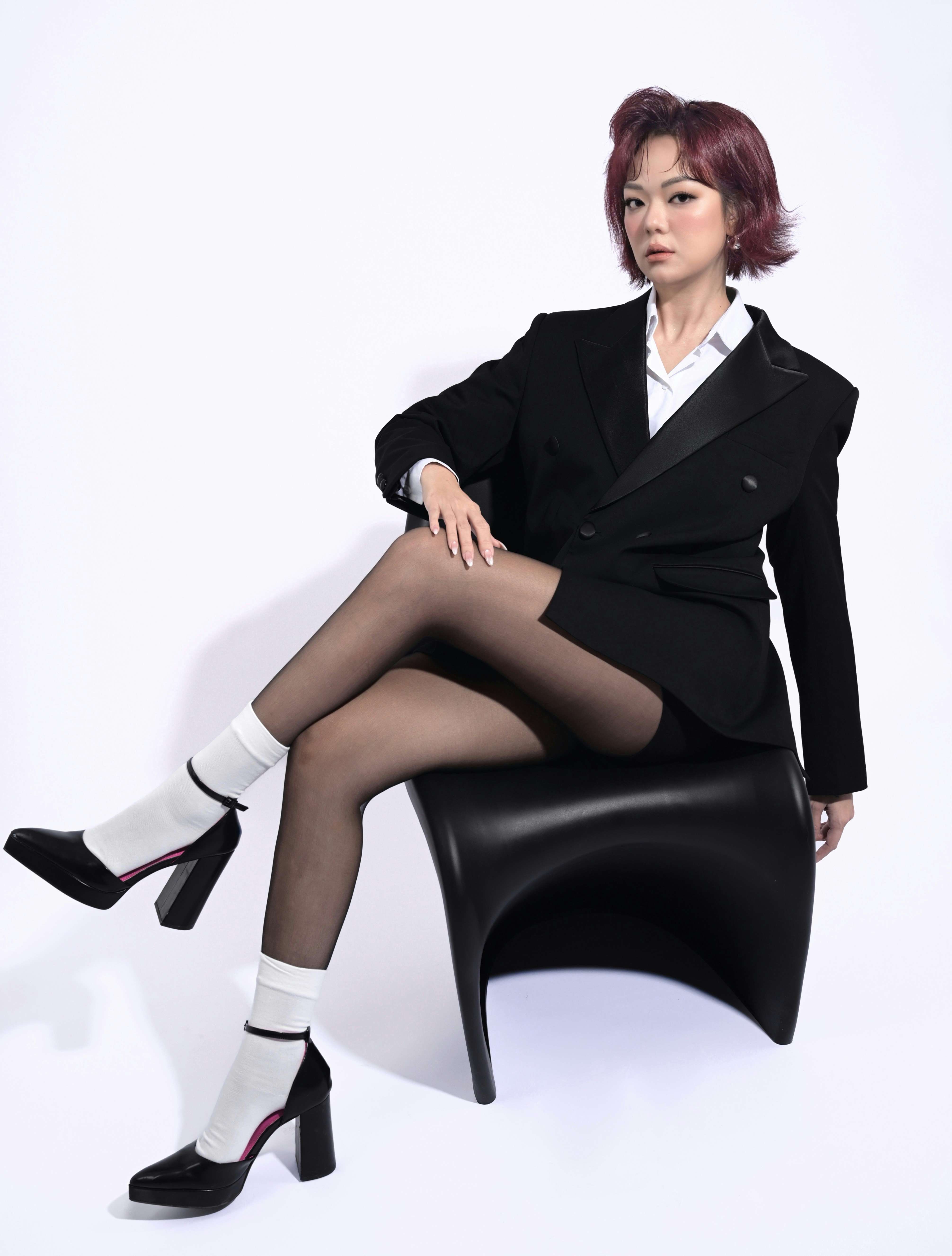 Simplicity will never get bored. | Woman in black blazer and skirt sitting on chair