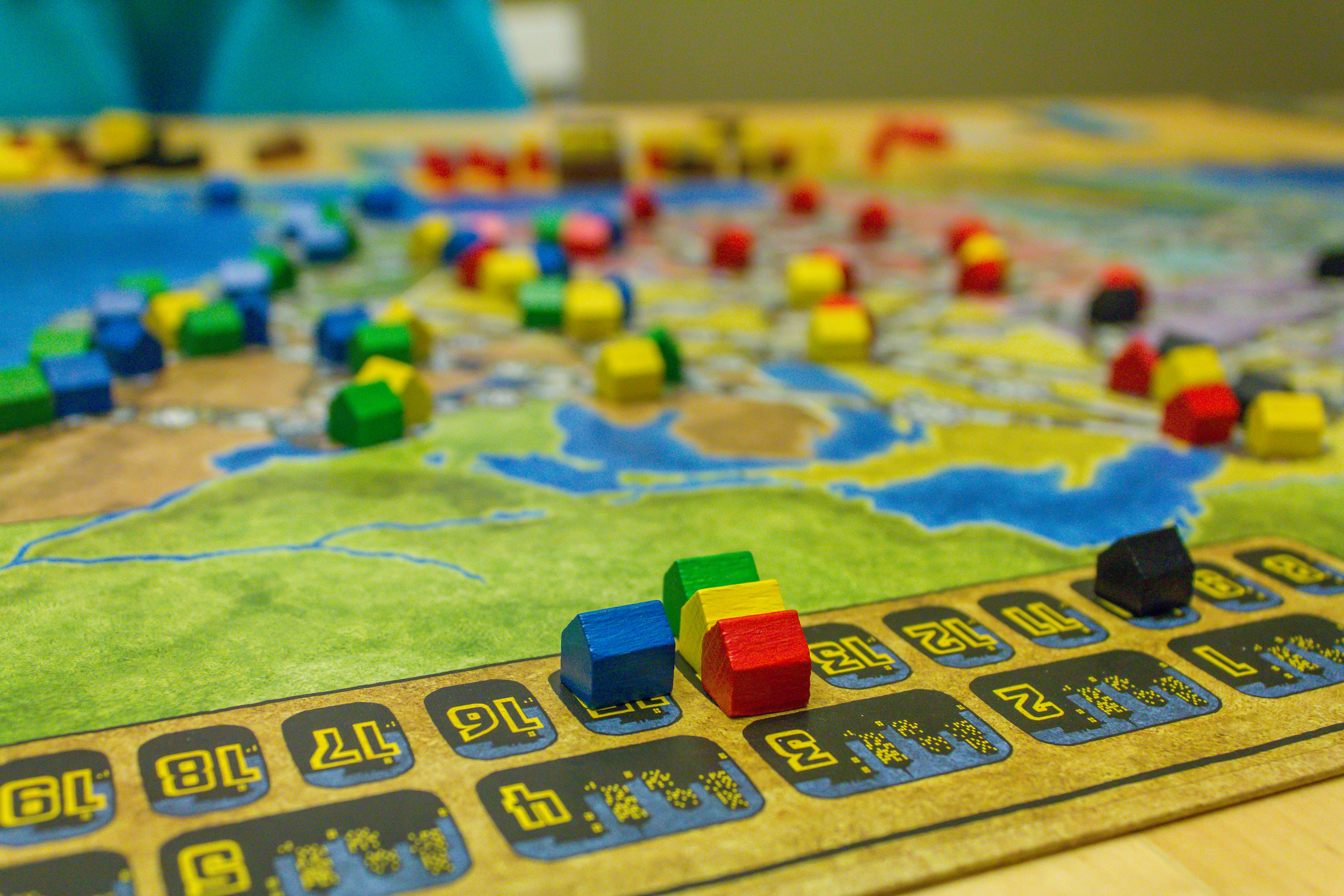 Colorful wooden game pieces on a map board. photo – Free Houses Image ...
